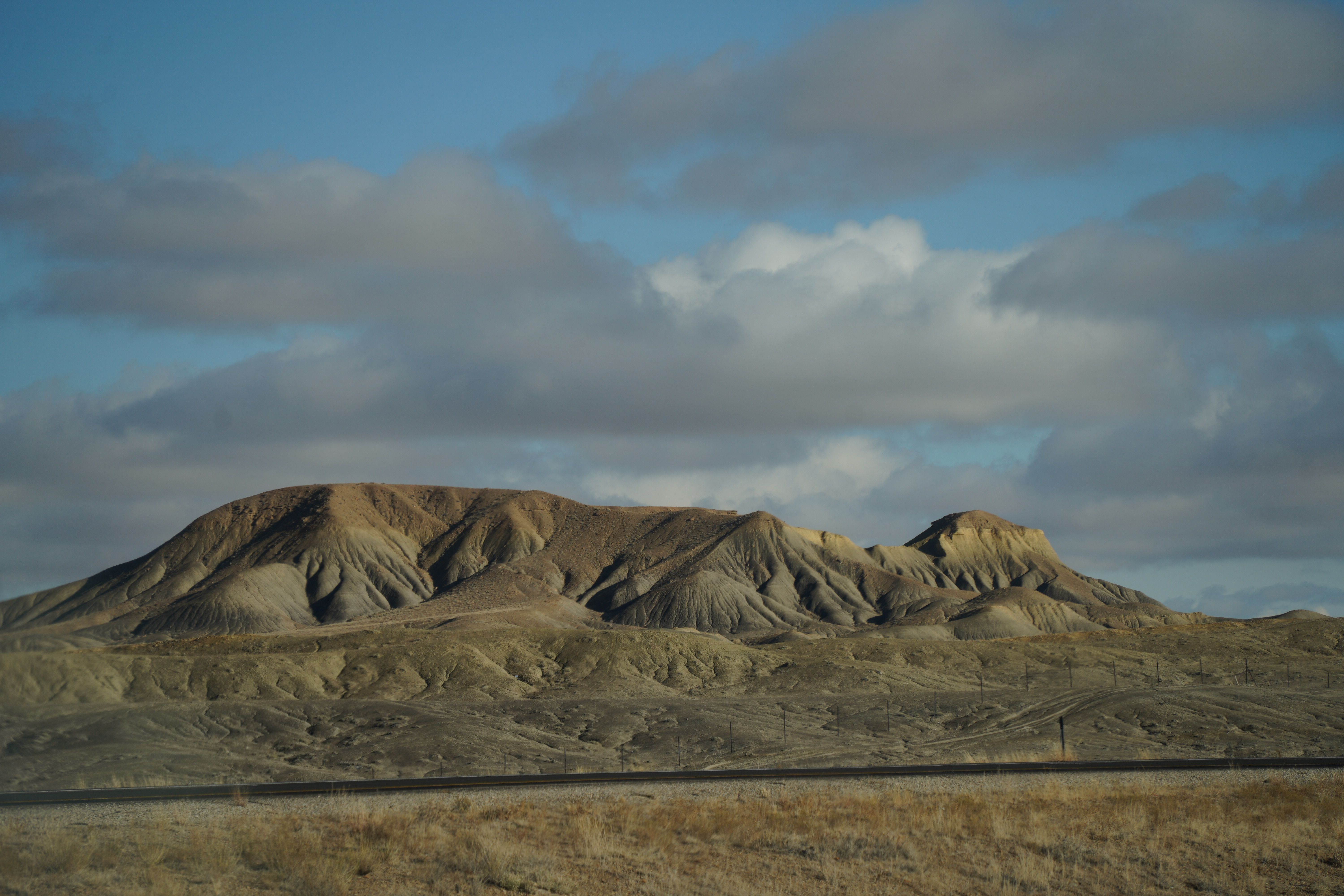 Dramatic Badlands Landscape under Cloudy Sky · Free Stock Photo