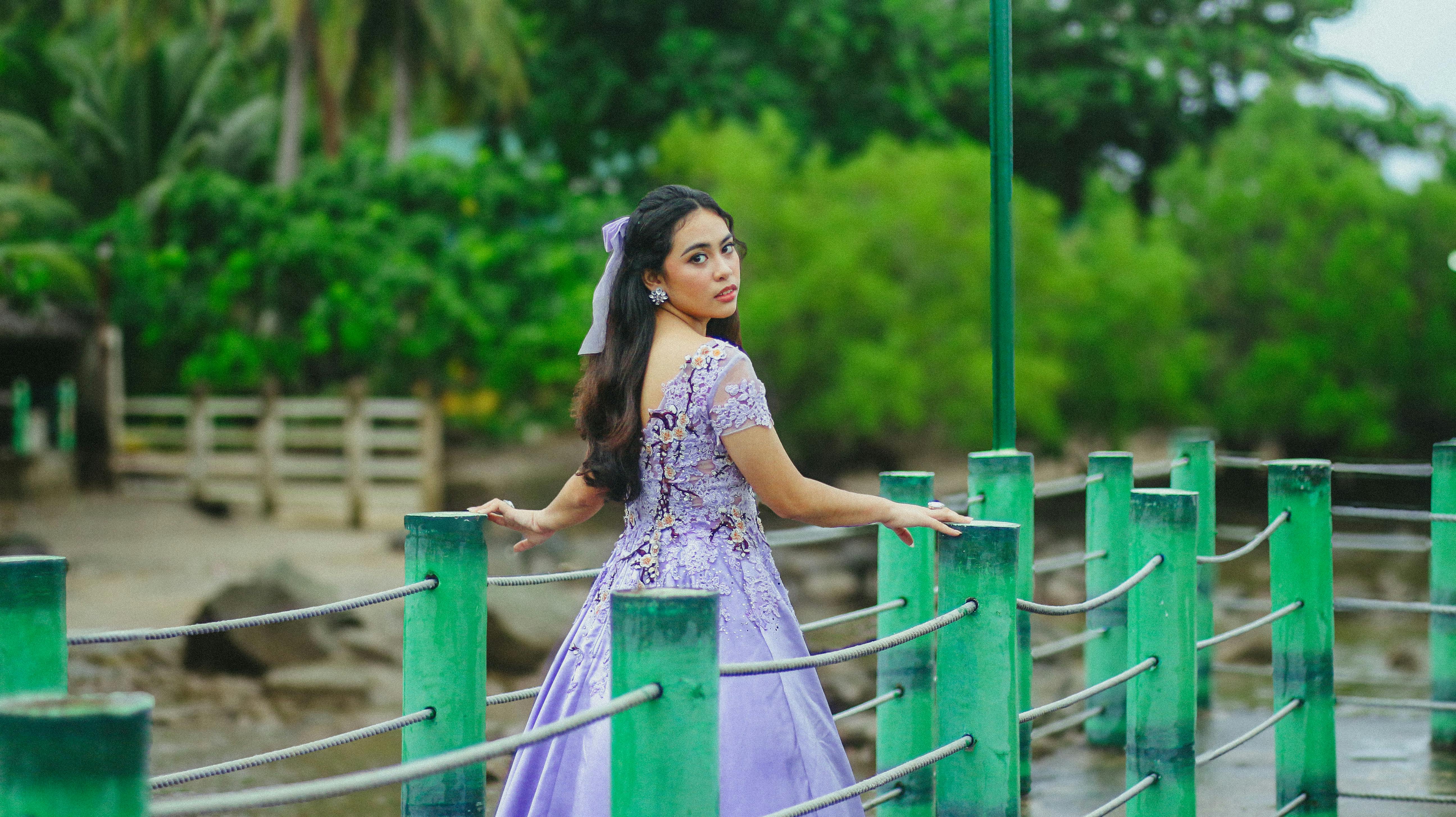Elegant woman in lavender gown on outdoor bridge · Free Stock Photo