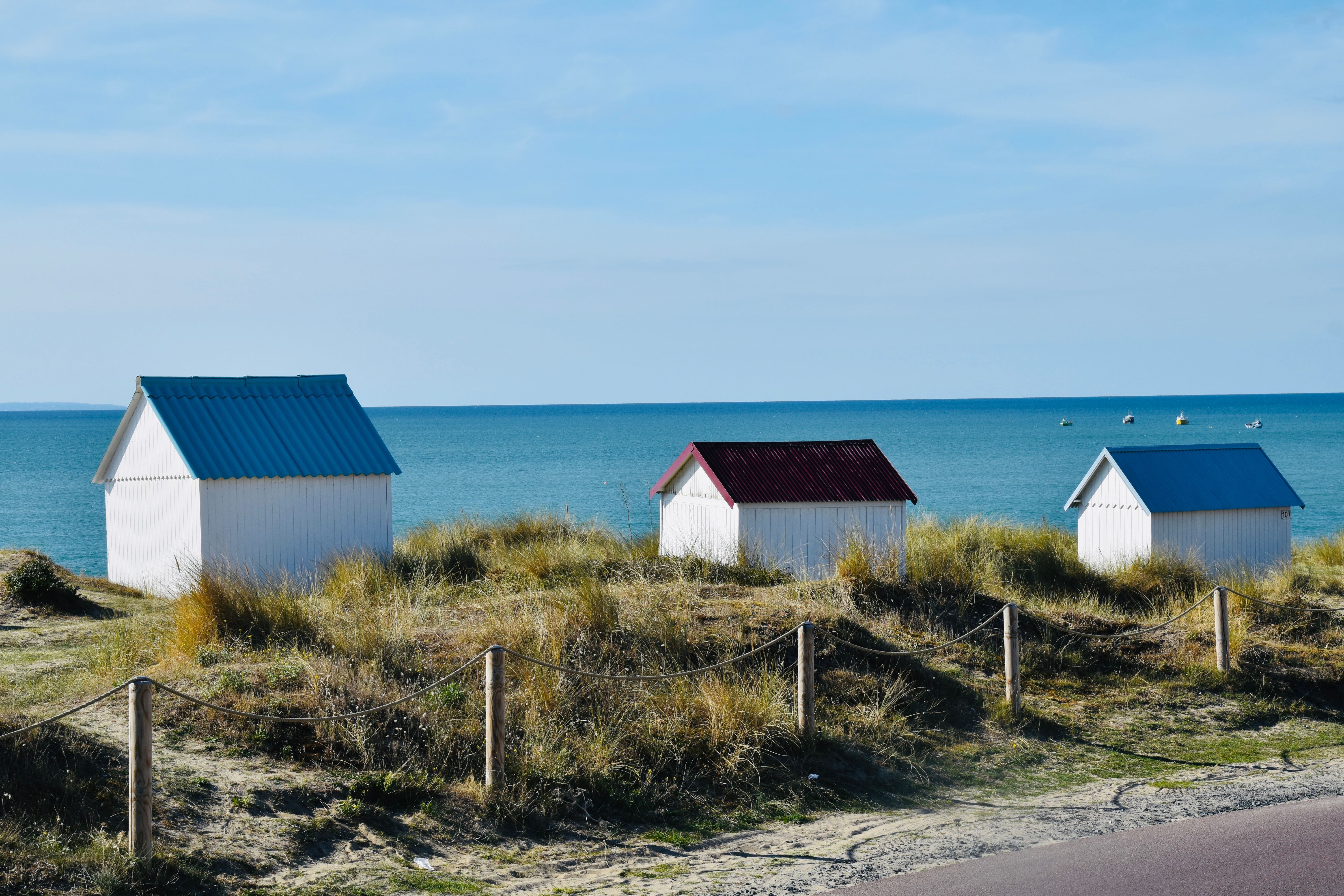 Tranquil Coastal Beach Huts by the Sea · Free Stock Photo