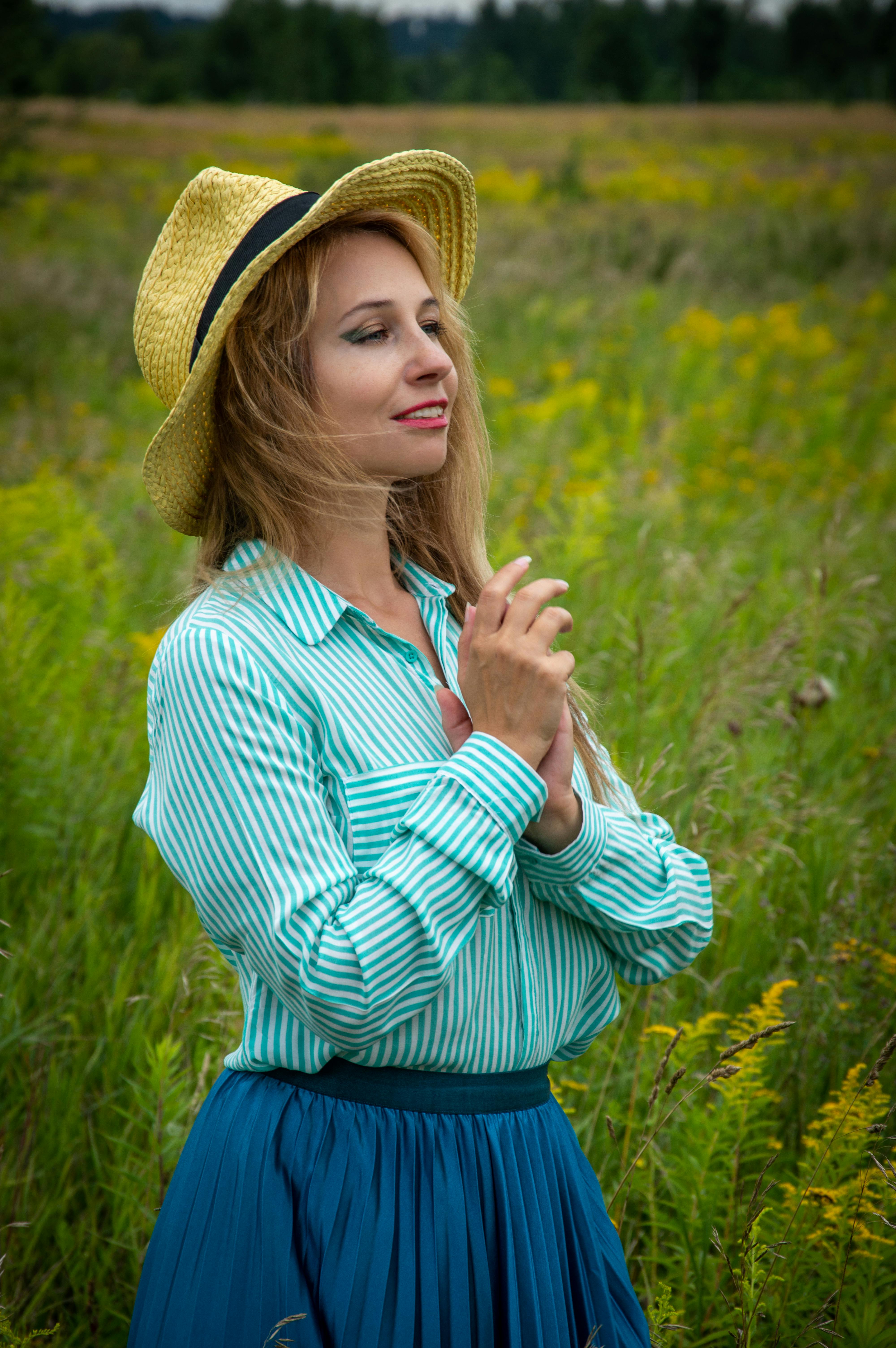 Joyful woman in a sunlit summer field · Free Stock Photo