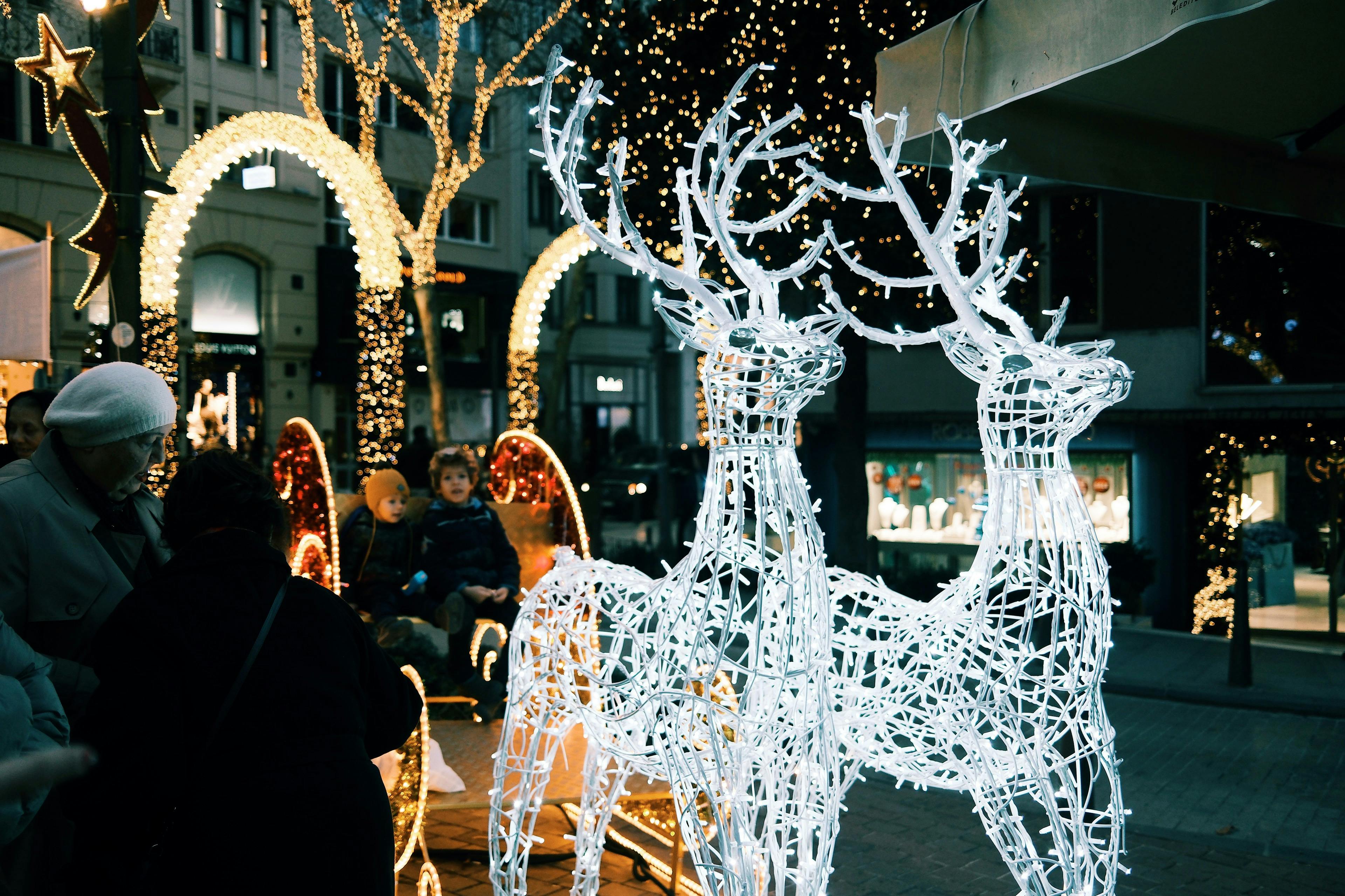 Festive Christmas street scene with light sculptures · Free Stock Photo