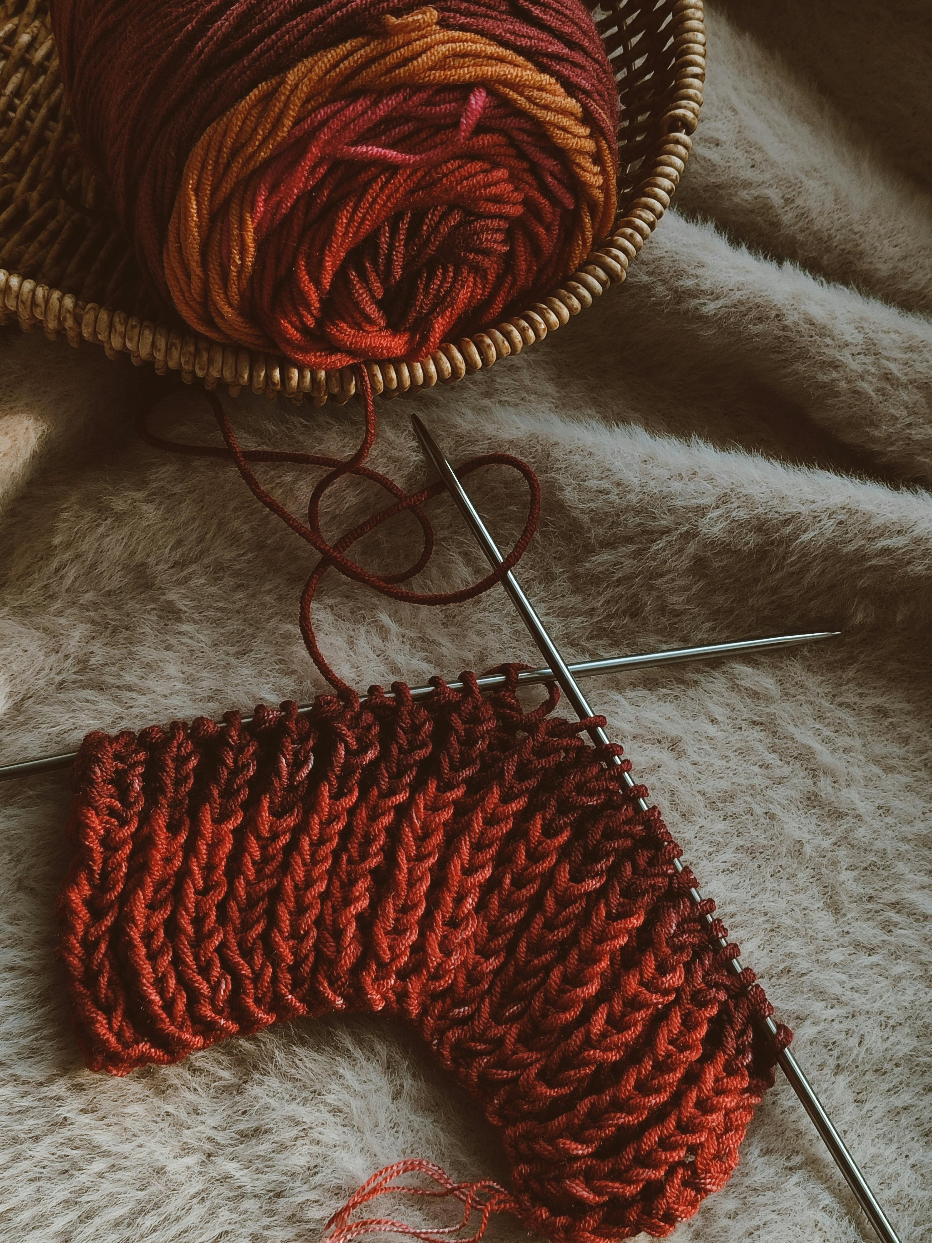 Cozy Knitting Scene with Red Yarn and Needles · Free Stock Photo