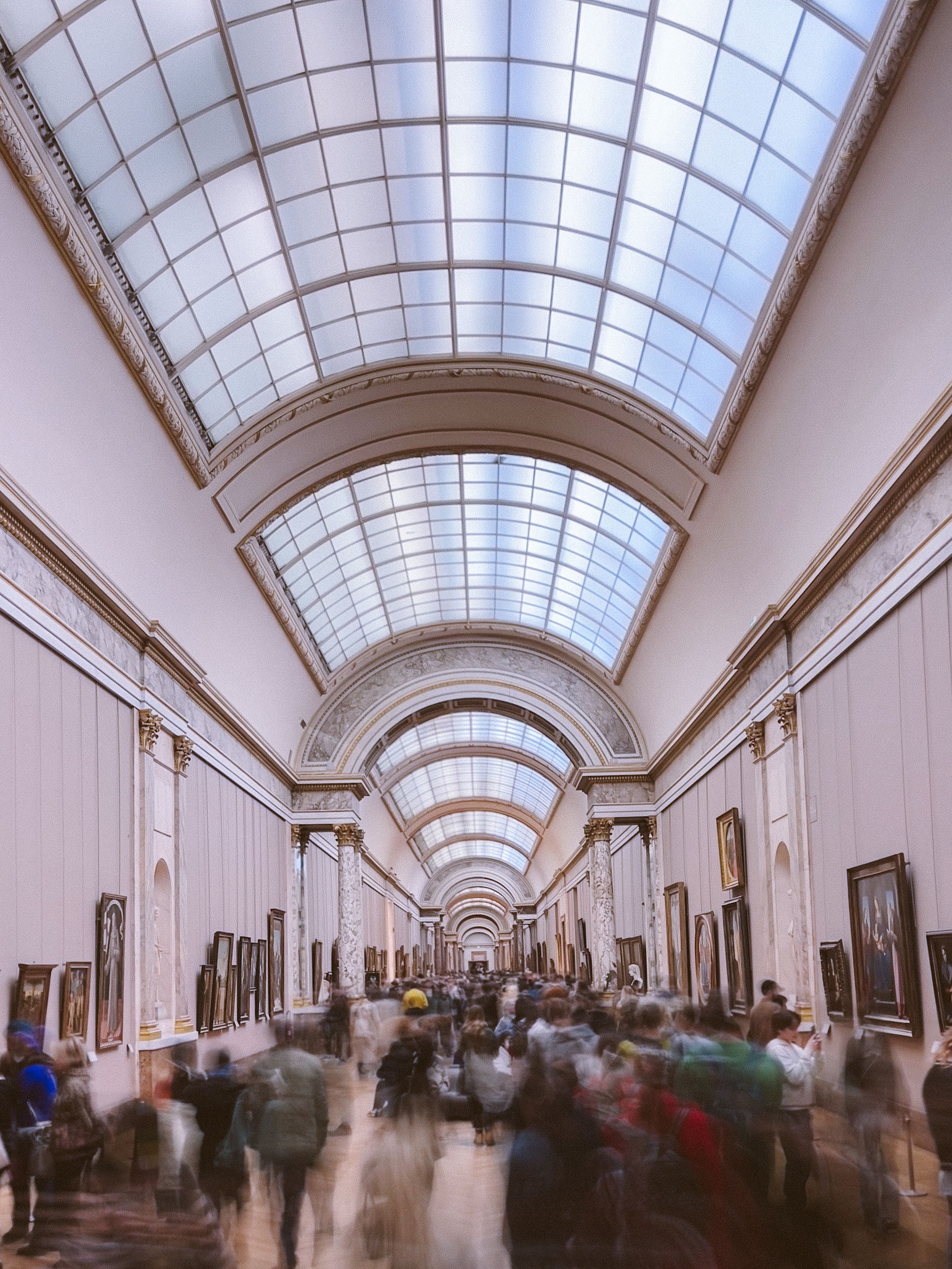 Vibrant Crowd in Louvre Museum Gallery · Free Stock Photo