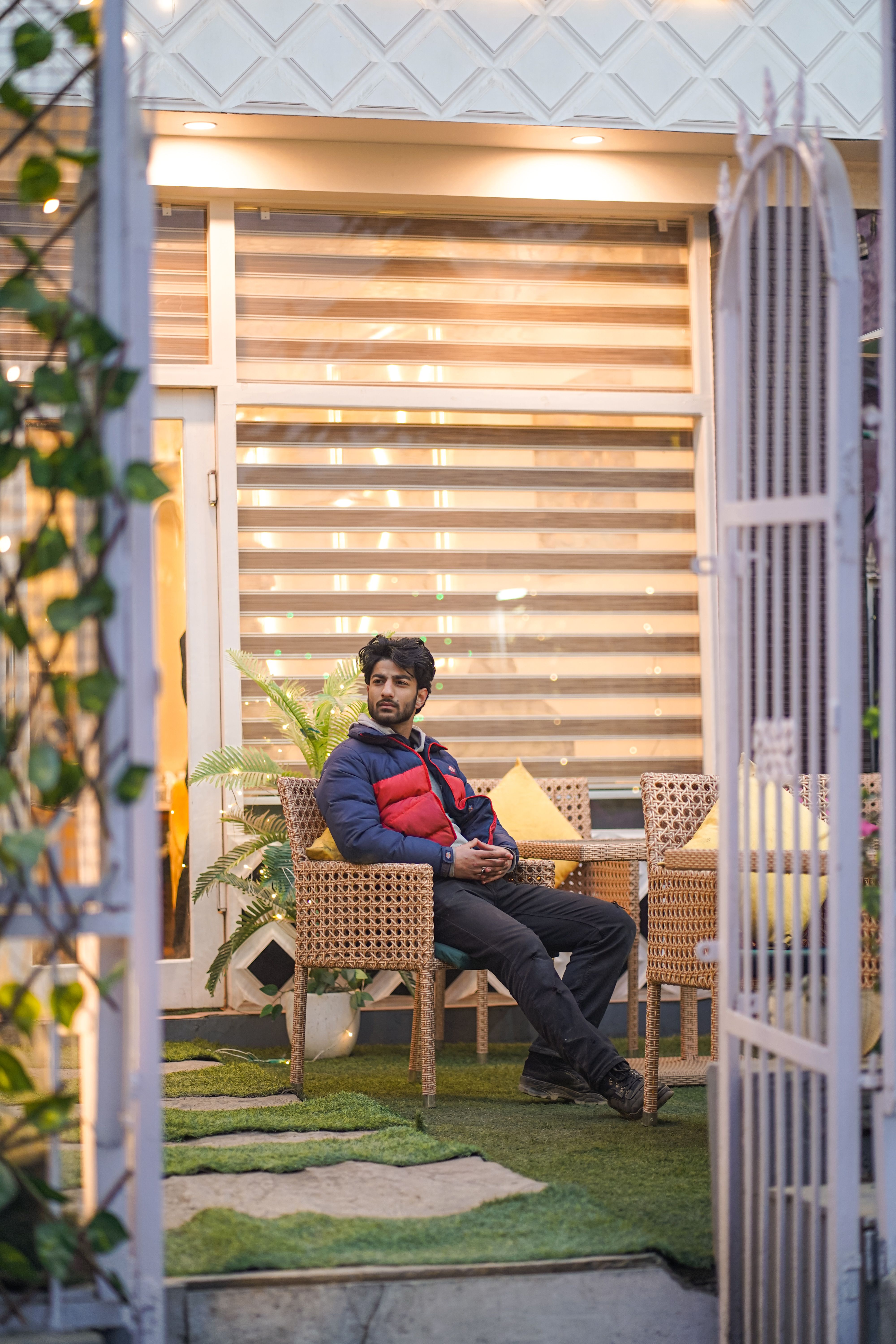 Man Relaxing Outdoors in Cozy Cafe Setting · Free Stock Photo
