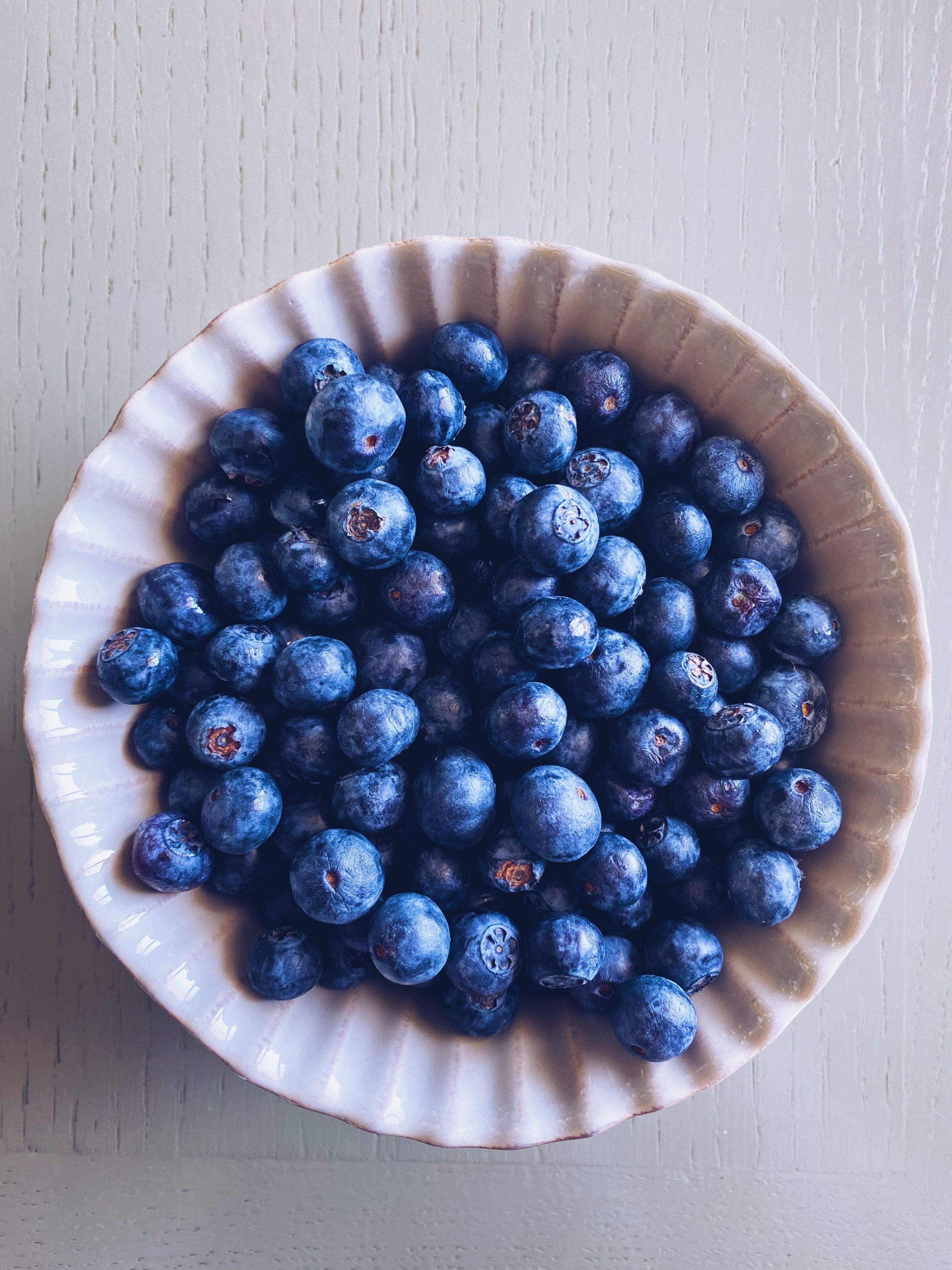 Blueberries on and near Plate · Free Stock Photo
