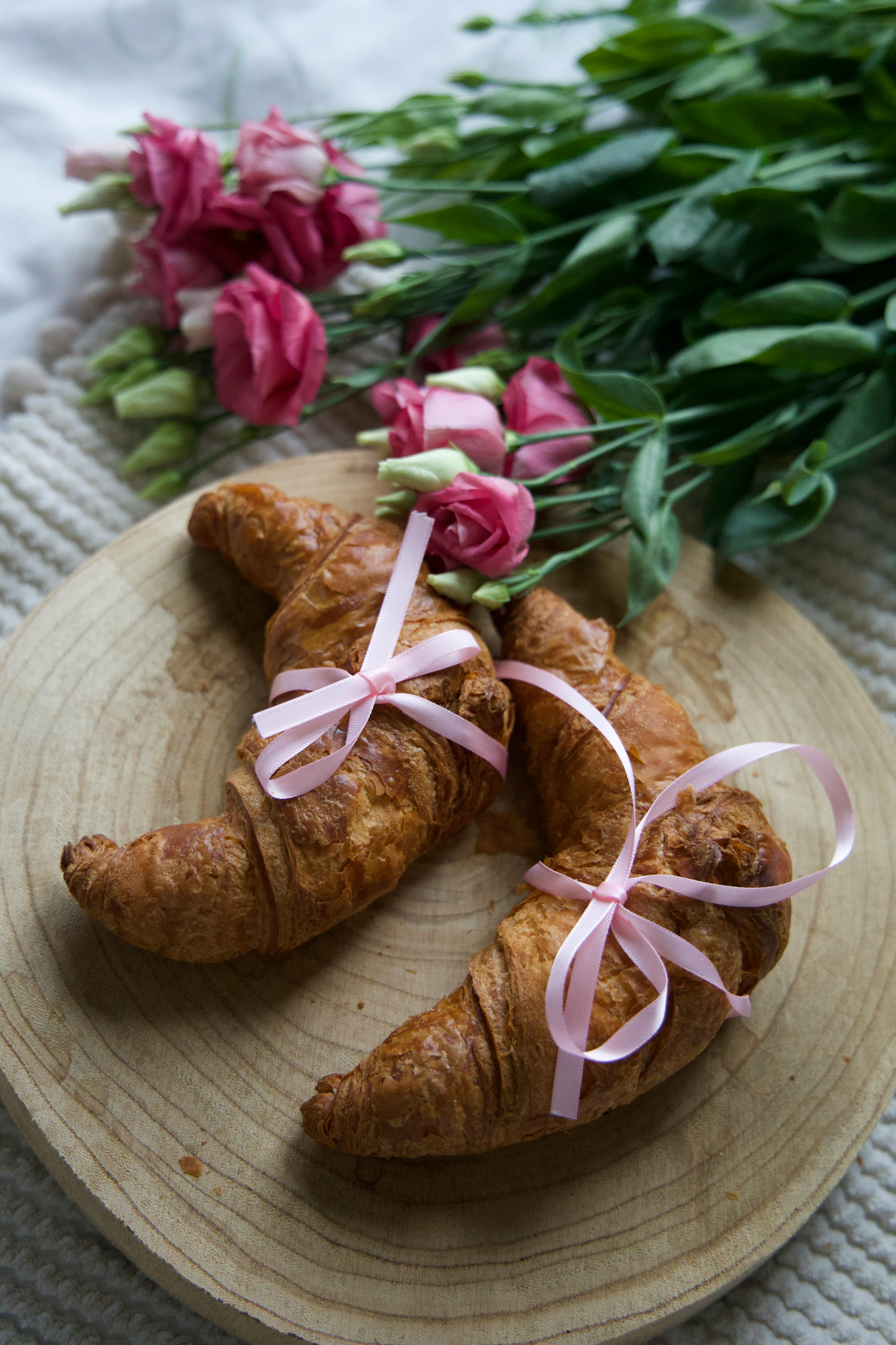 Elegant Croissants with Pink Ribbon and Flowers · Free Stock Photo