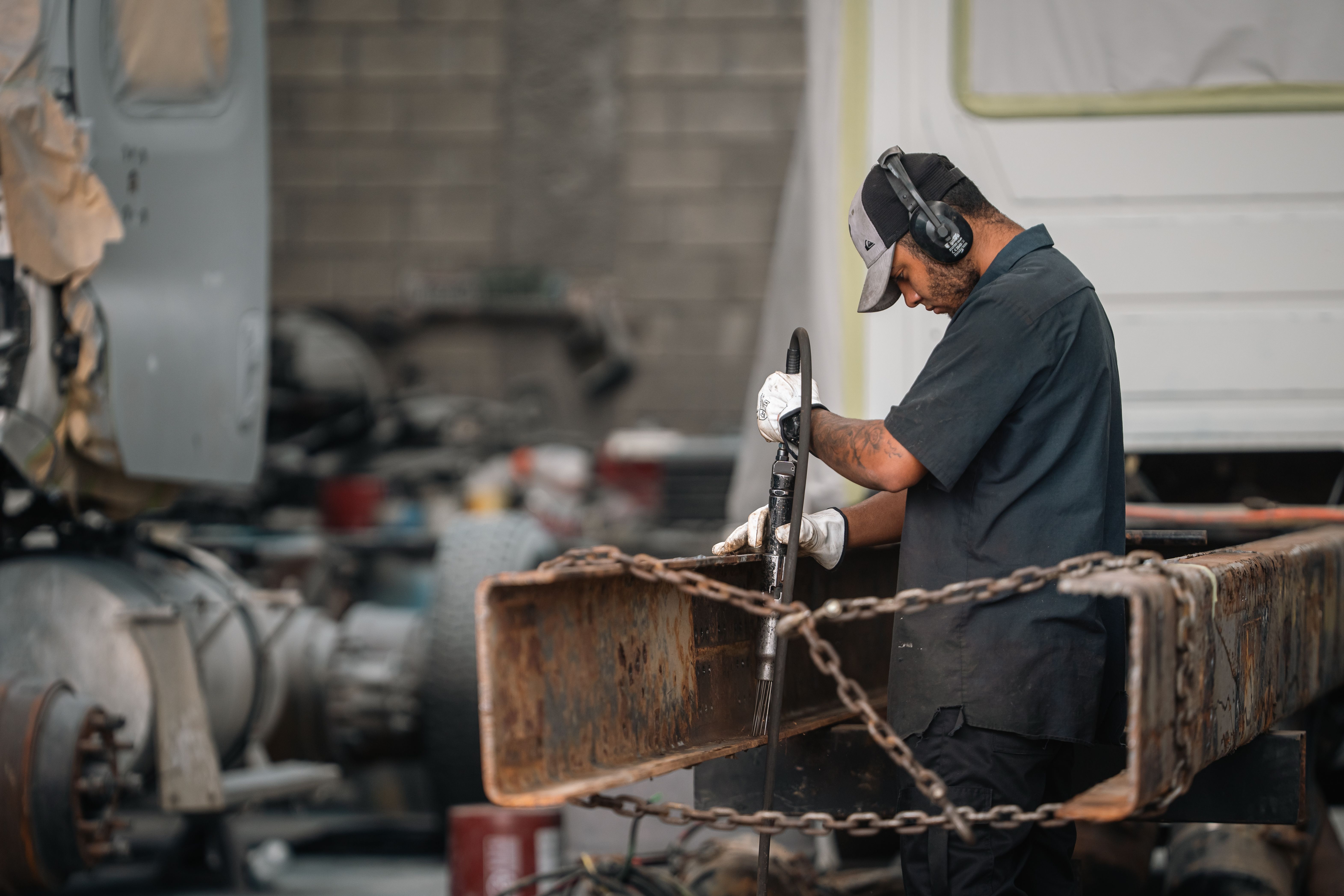 Mechanic Working in an Industrial Garage · Free Stock Photo