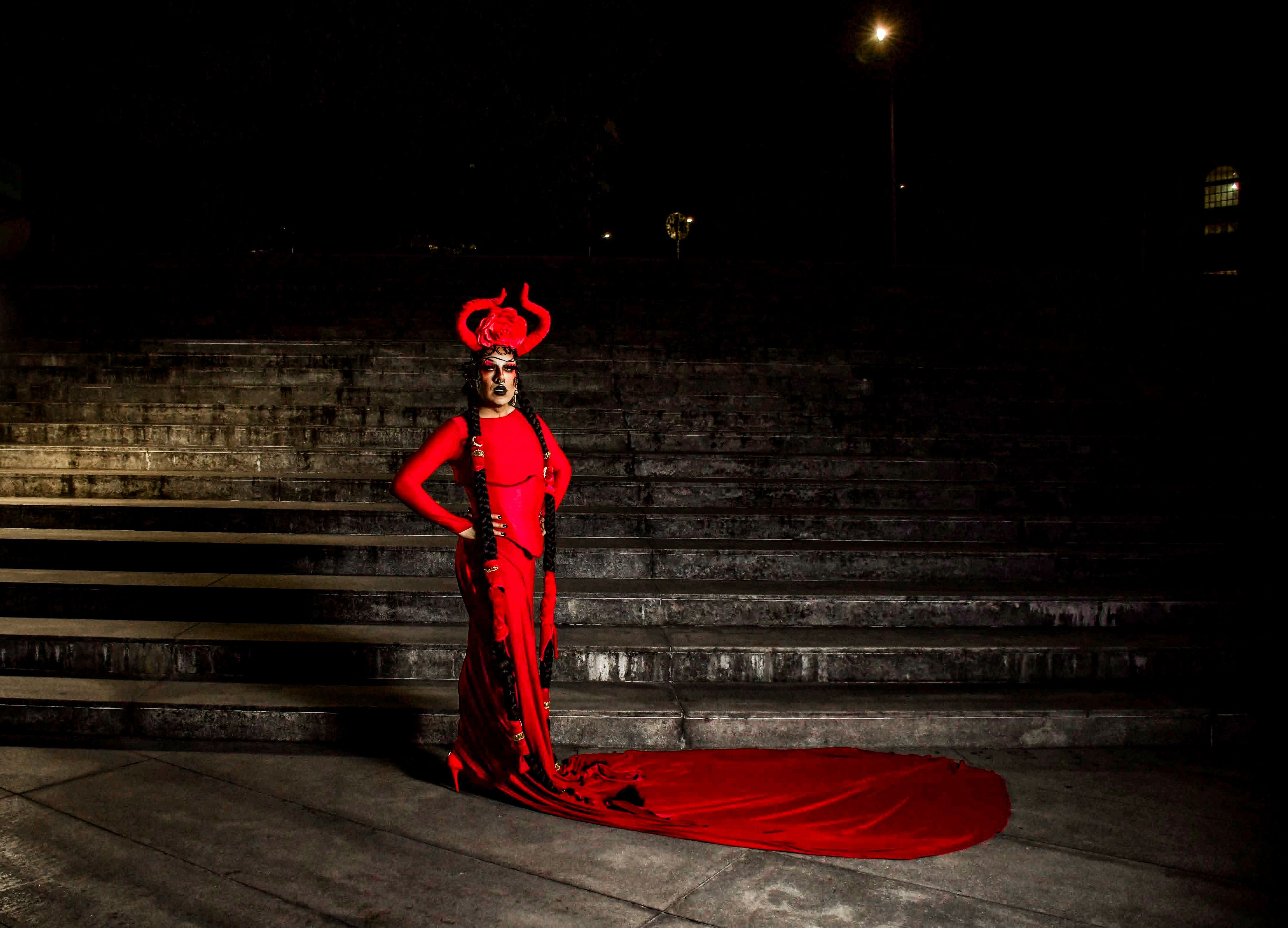 Striking Performer in Dramatic Red Costume at Night · Free Stock Photo