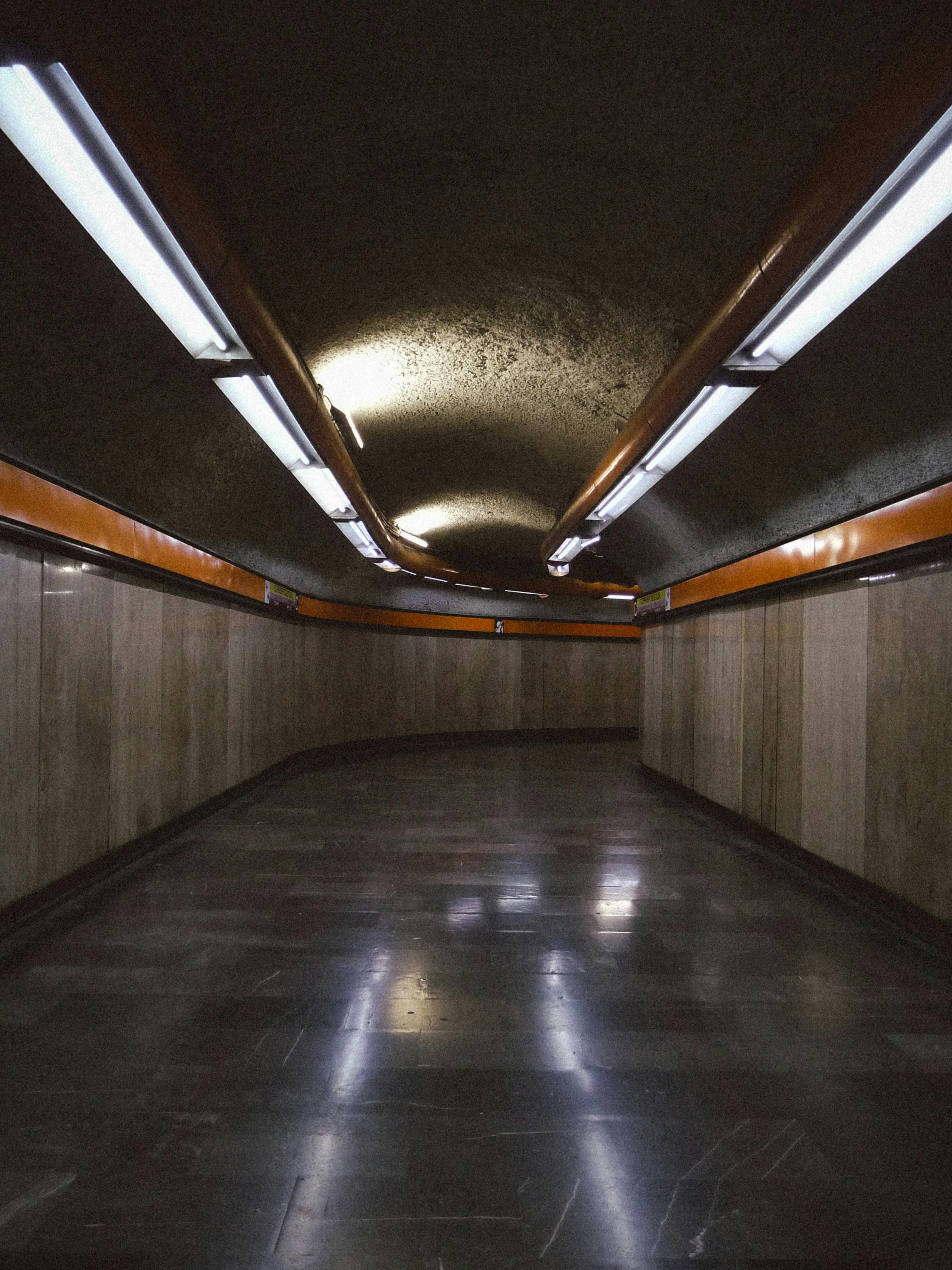 Dimly Lit Underground Tunnel Interior View · Free Stock Photo