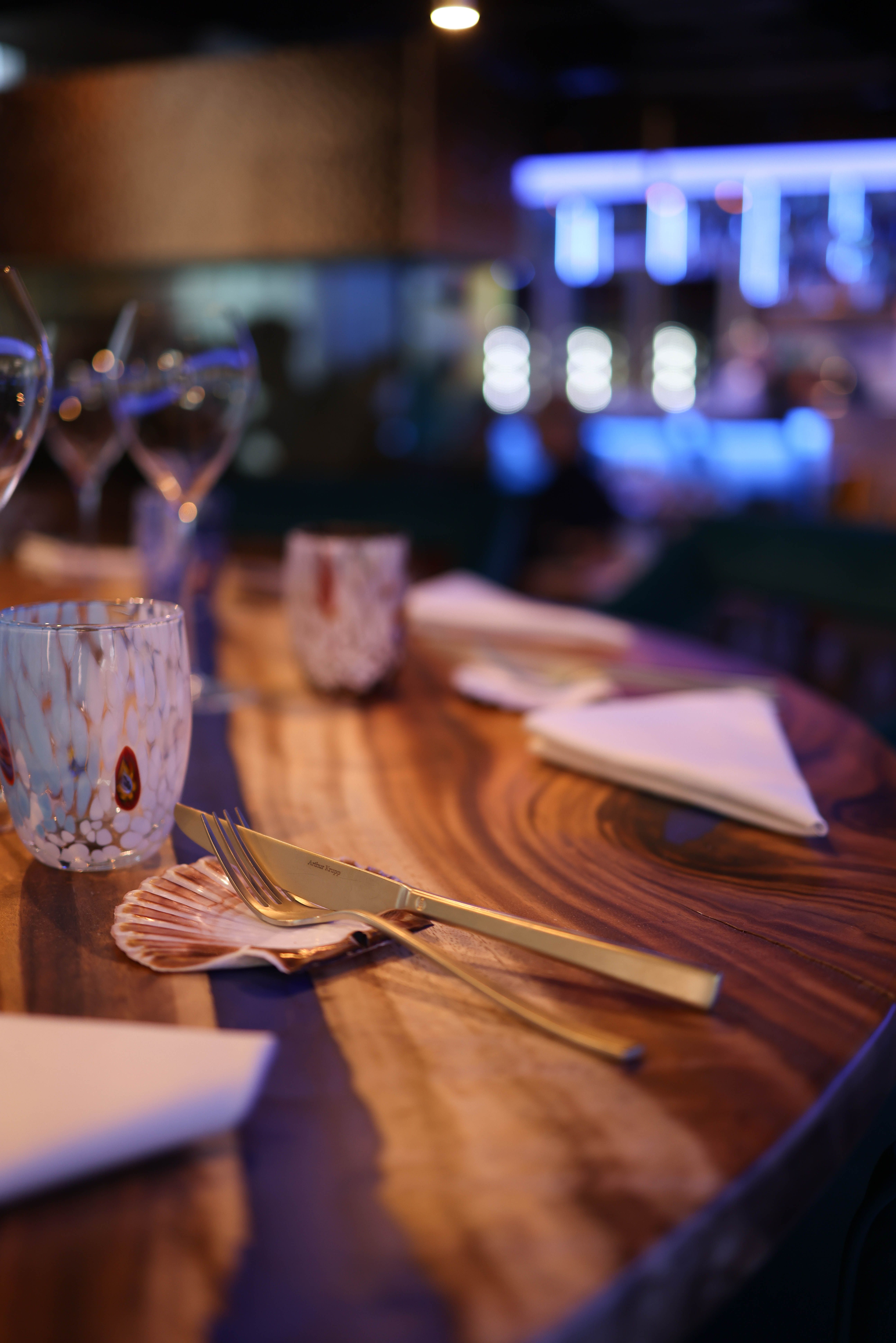 Elegant Restaurant Table Setting with Ambient Lighting · Free Stock Photo