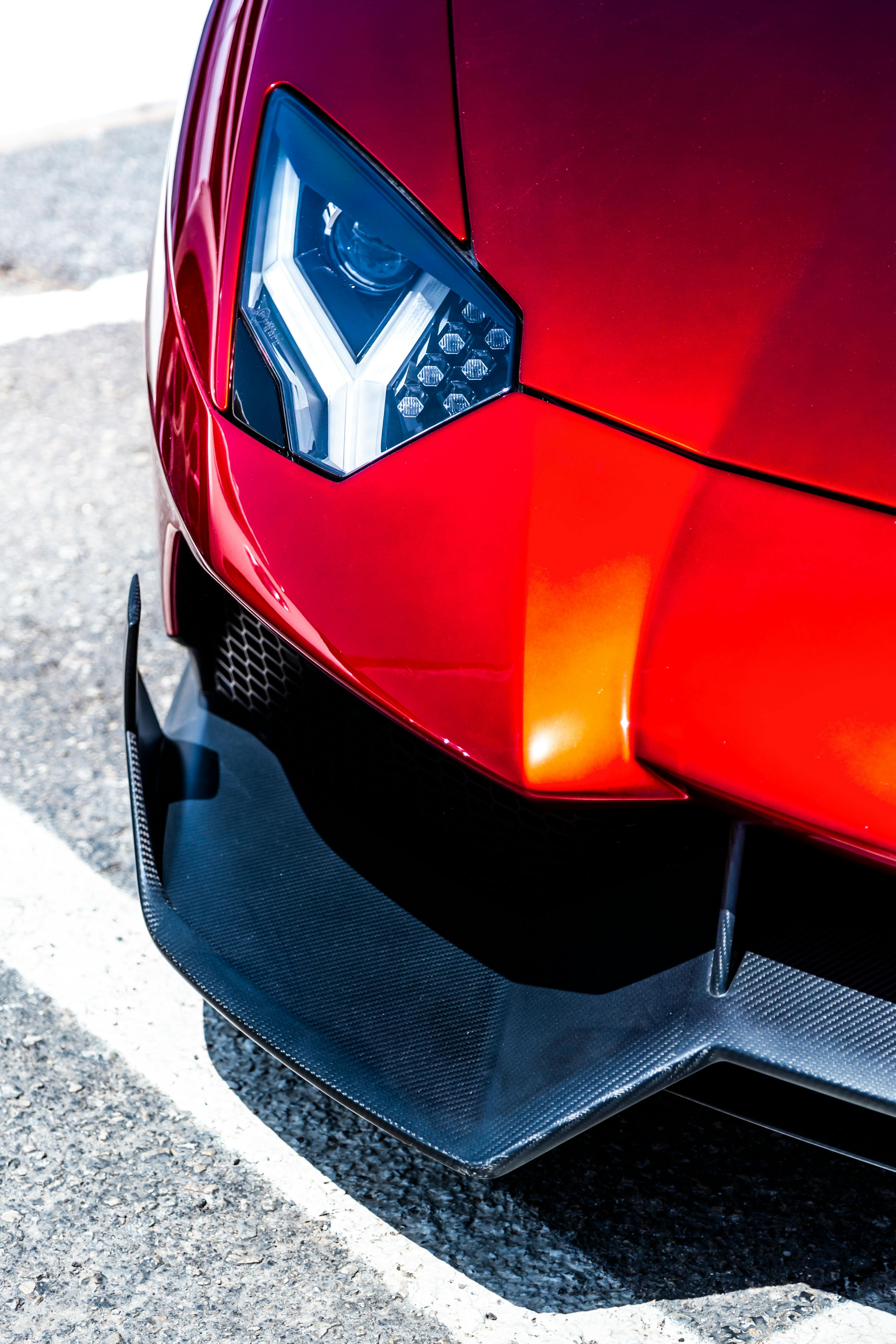 Close-up of a Sleek Red Supercar Front Design · Free Stock Photo