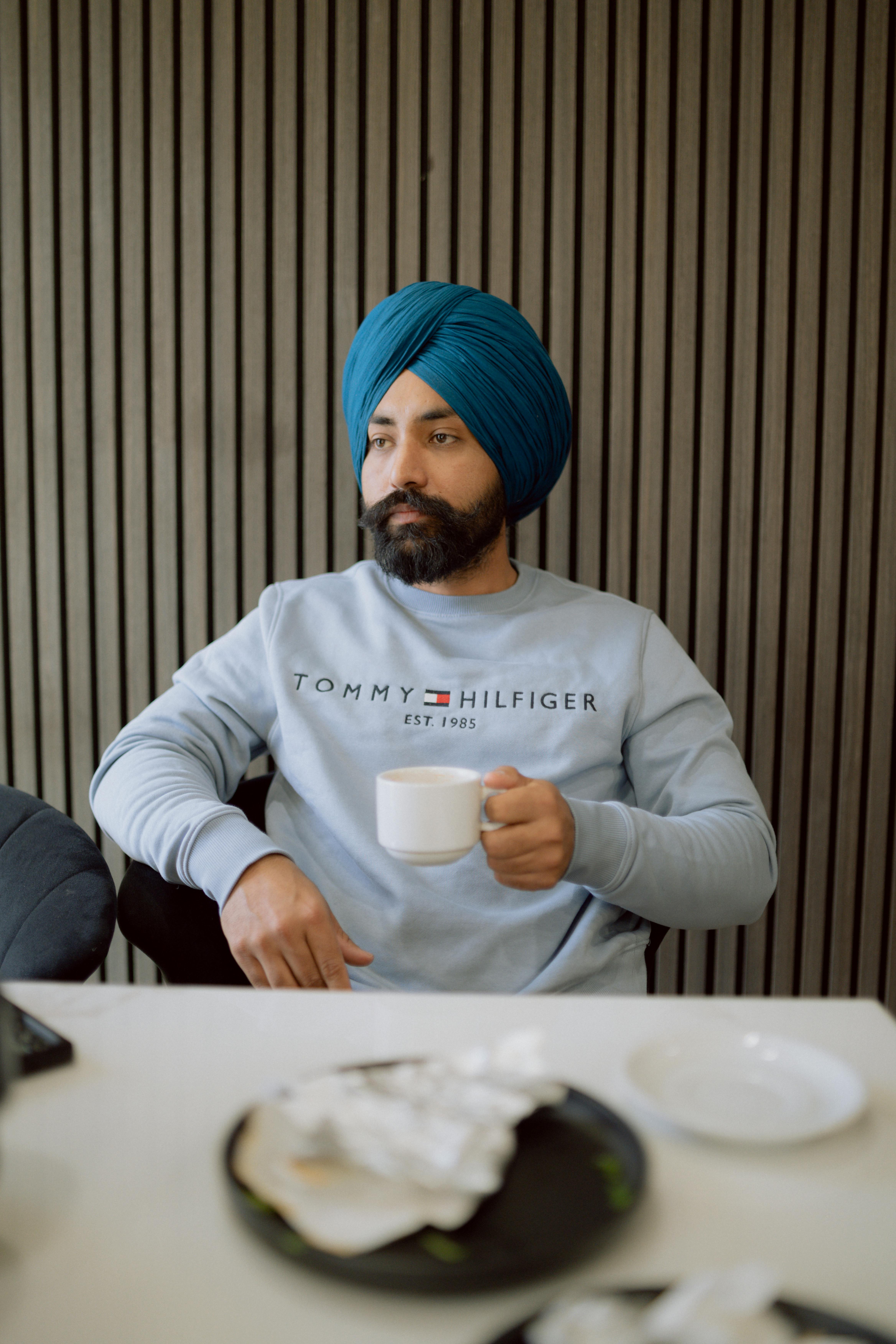 Man with Blue Turban Enjoying Coffee Indoors · Free Stock Photo
