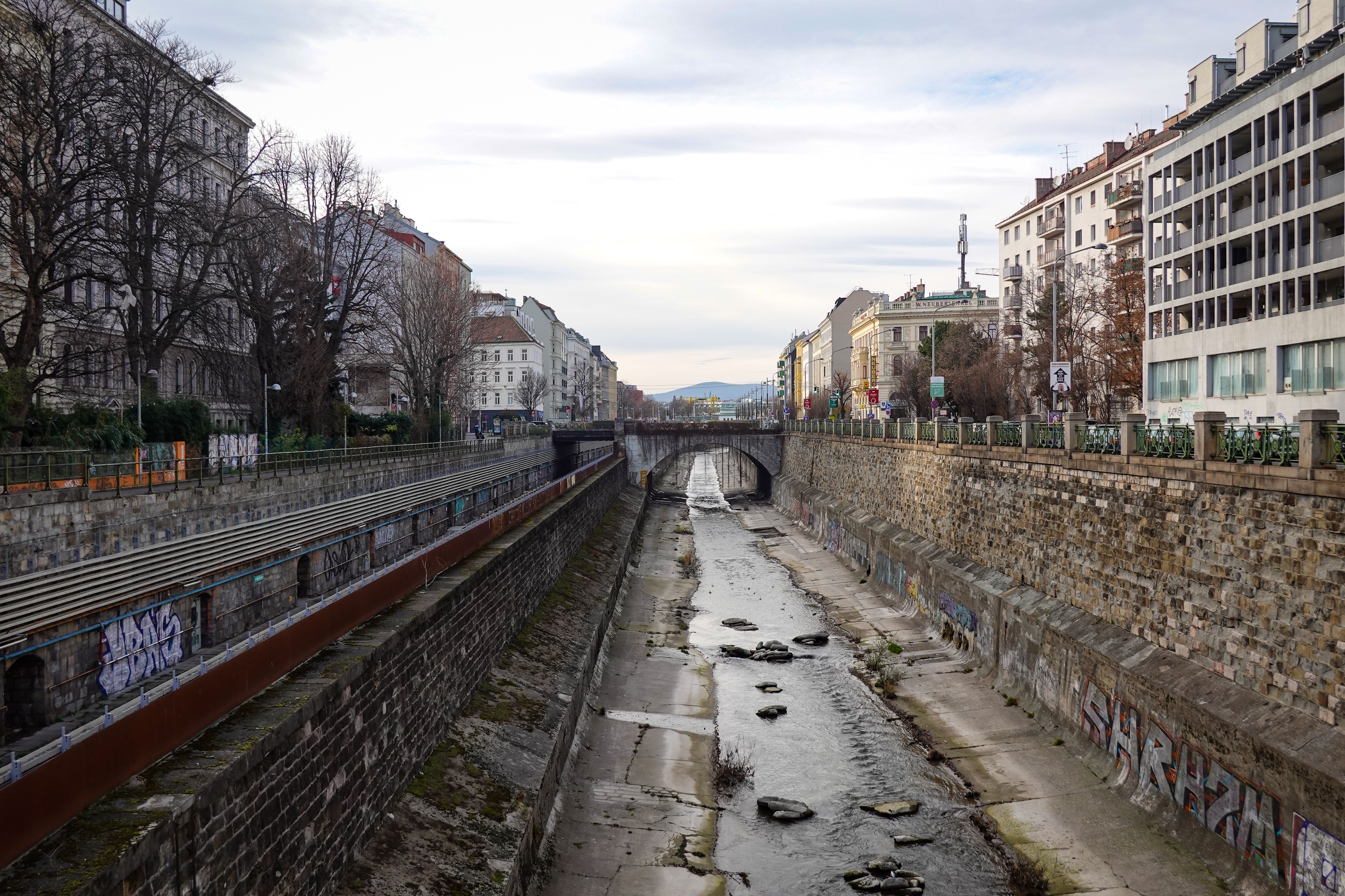 Urban River Canal Through Cityscape · Free Stock Photo