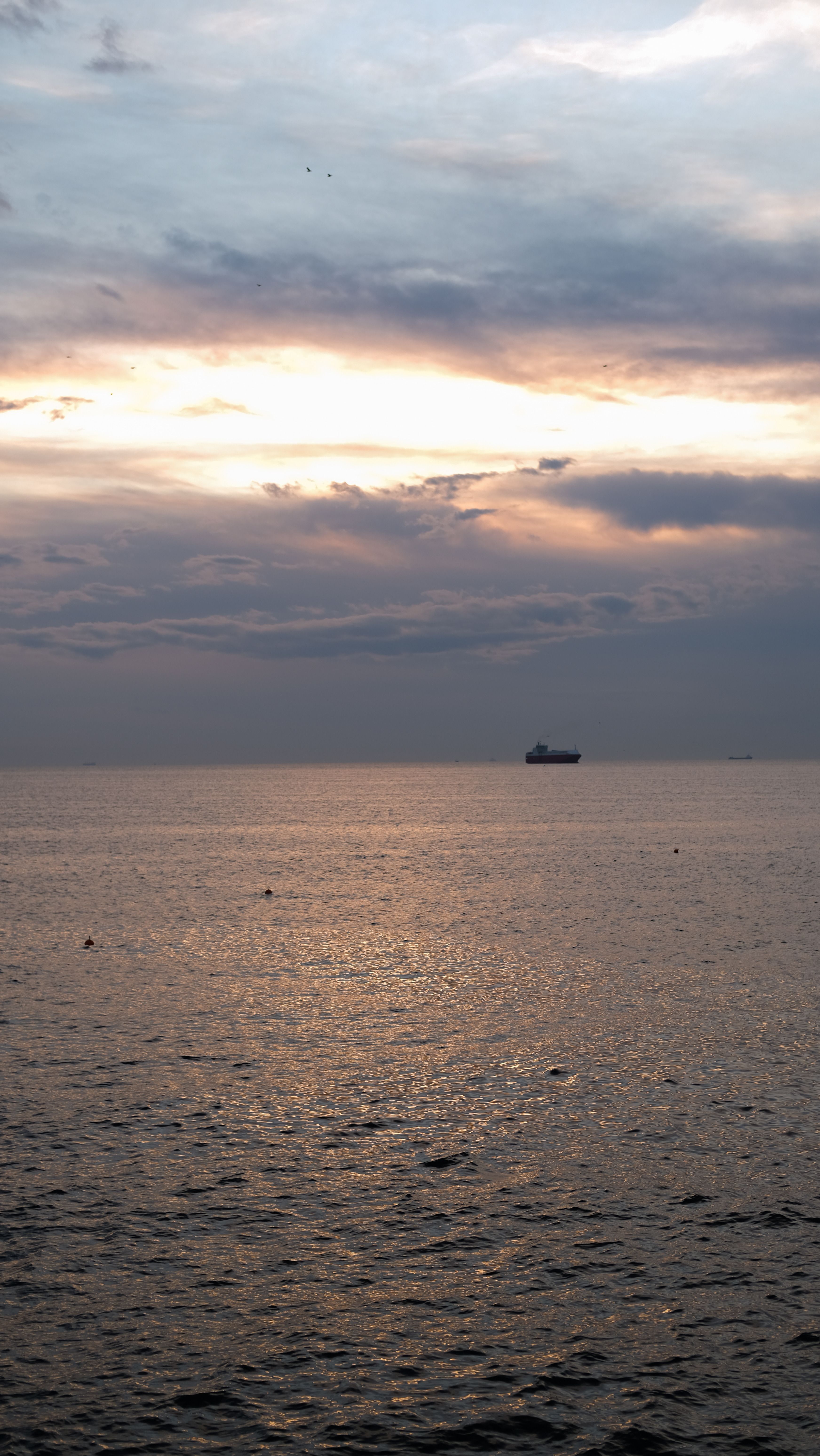 Dramatic Ocean Sunset with Ship Silhouette · Free Stock Photo