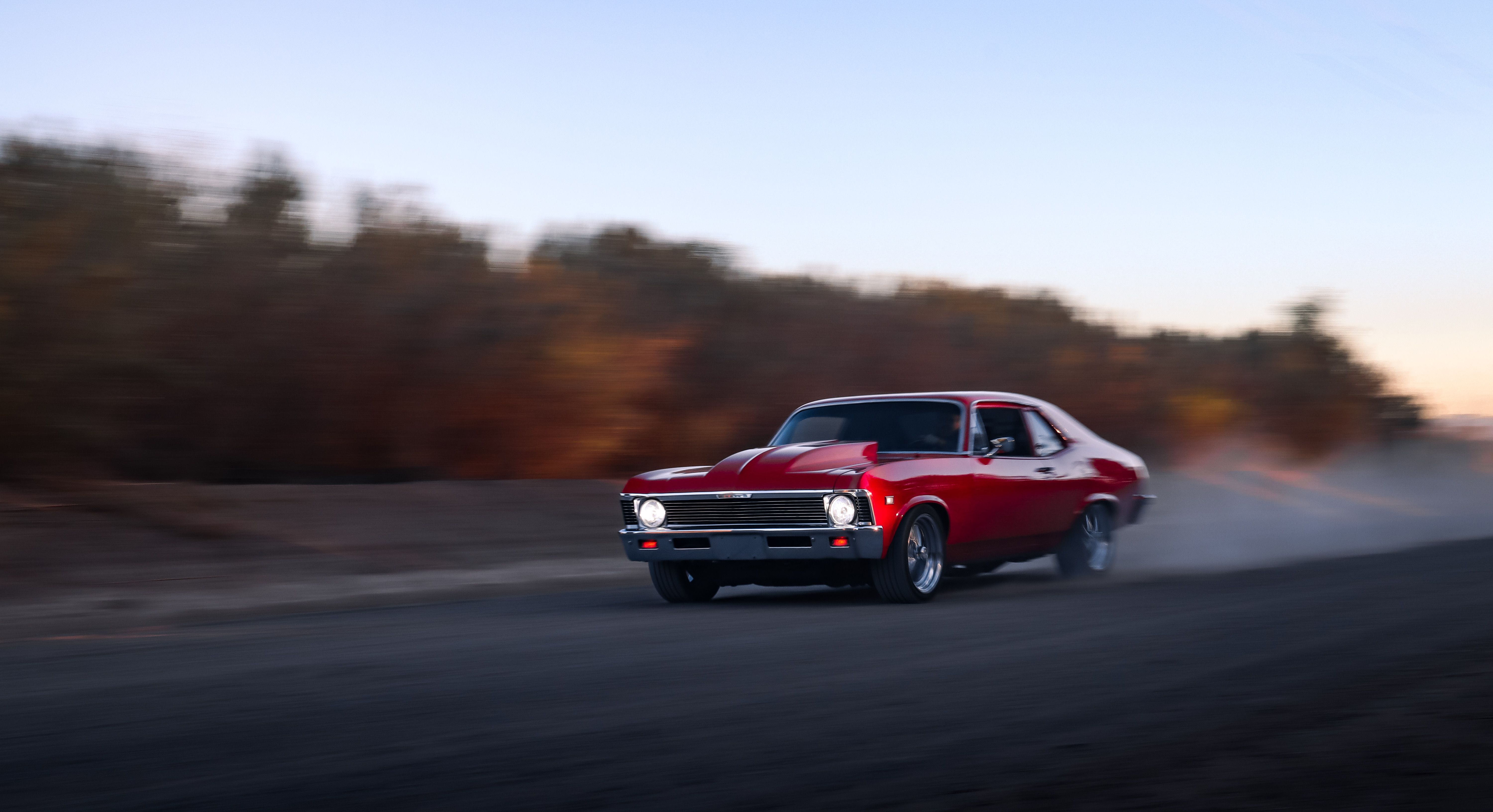 Classic Red Muscle Car Driving at Sunset · Free Stock Photo
