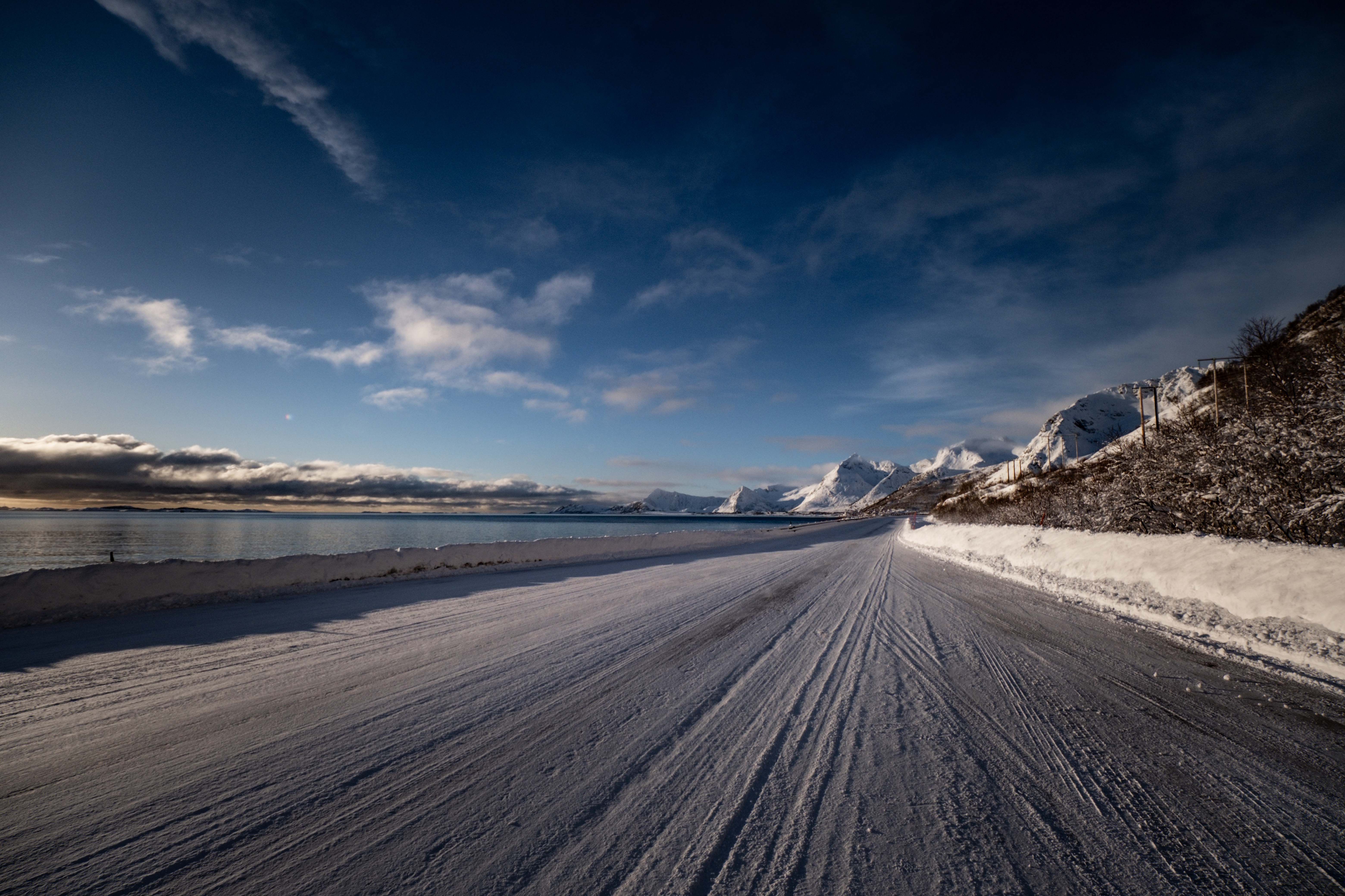 Snowy Coastal Road with Mountain View at Twilight · Free Stock Photo