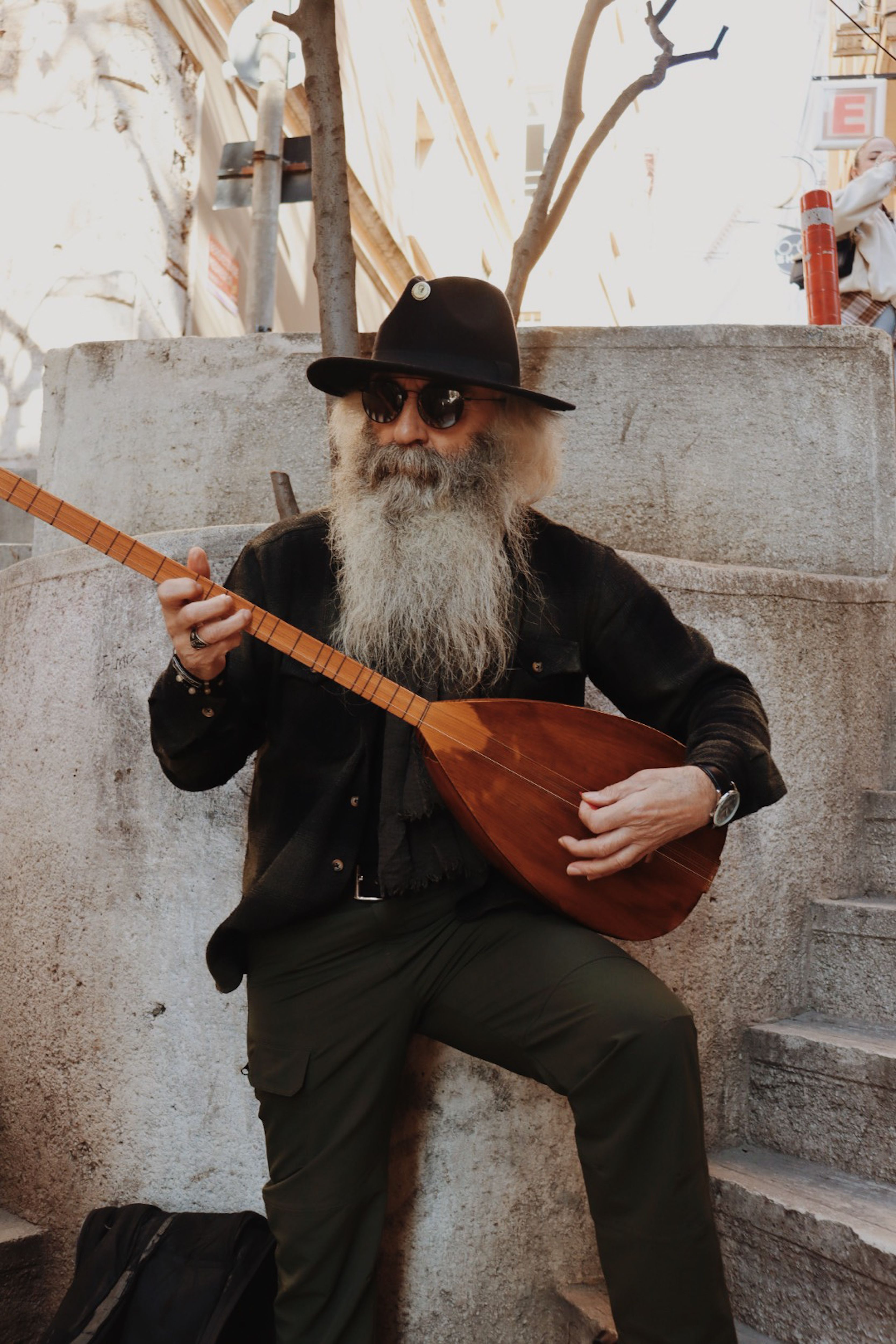 Street Musician Playing Traditional Instrument Outdoors · Free Stock Photo