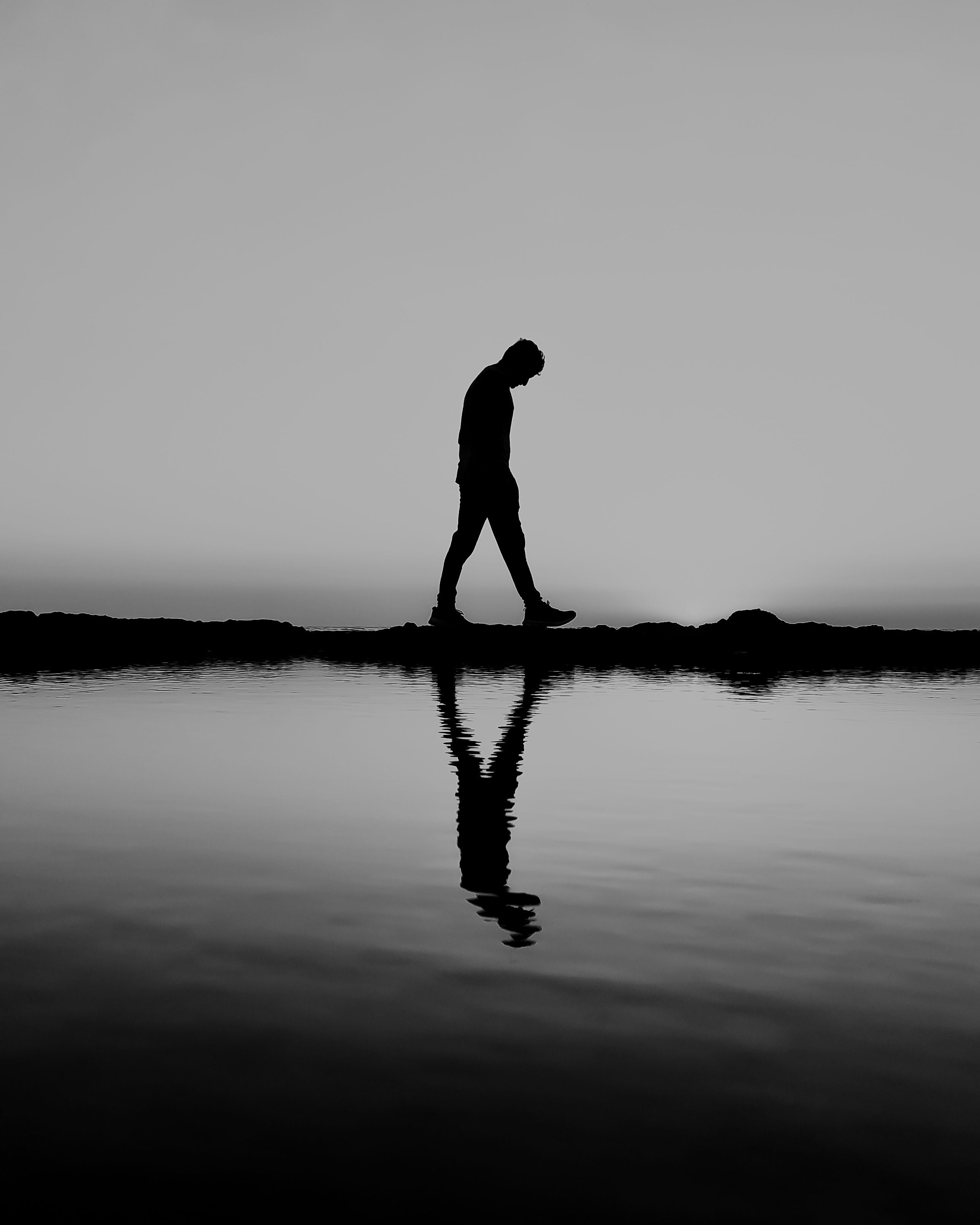 Dramatic Silhouette Reflection by Water · Free Stock Photo