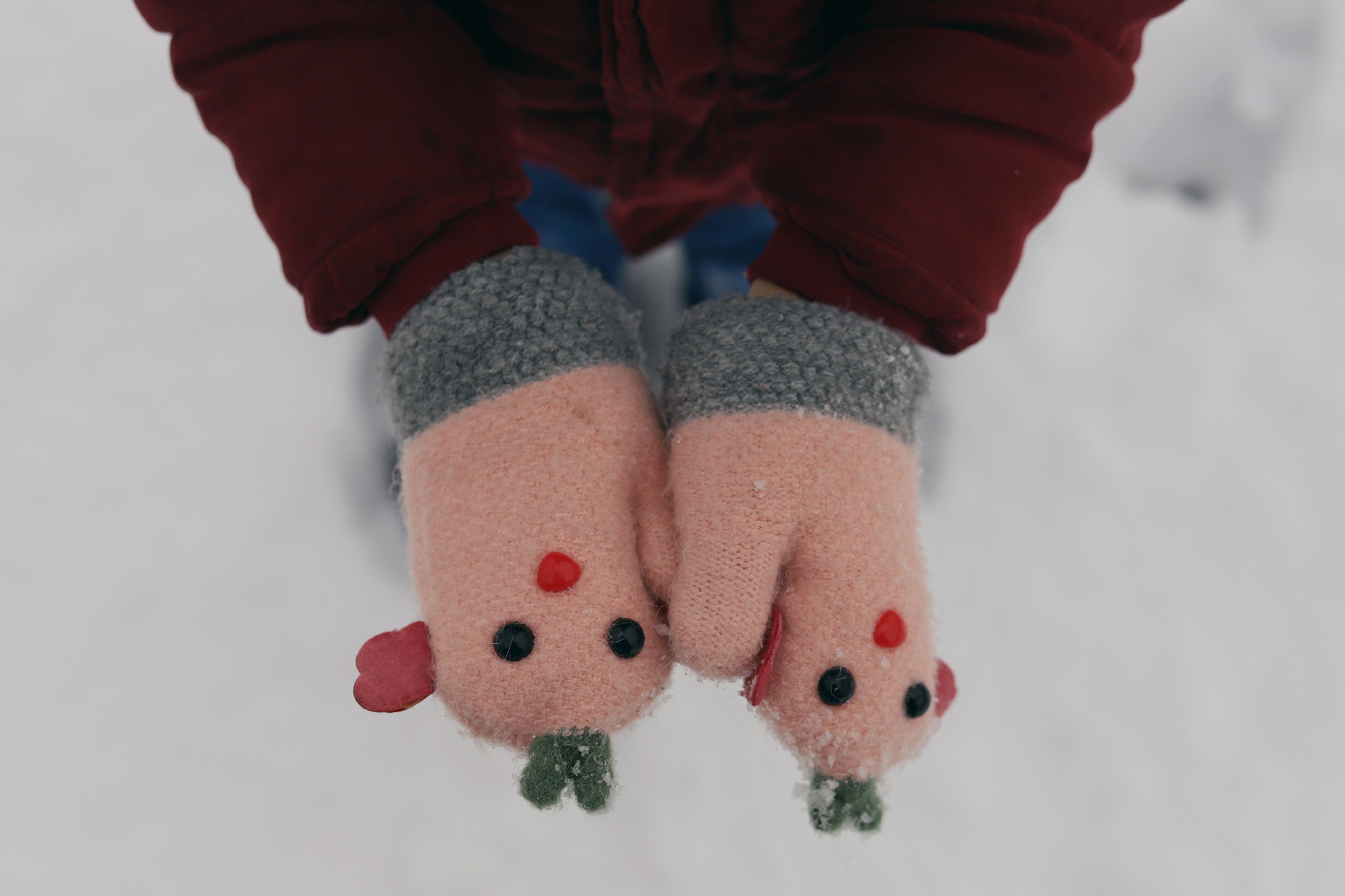 Child Wearing Cute Winter Gloves in Snowy Setting · Free Stock Photo
