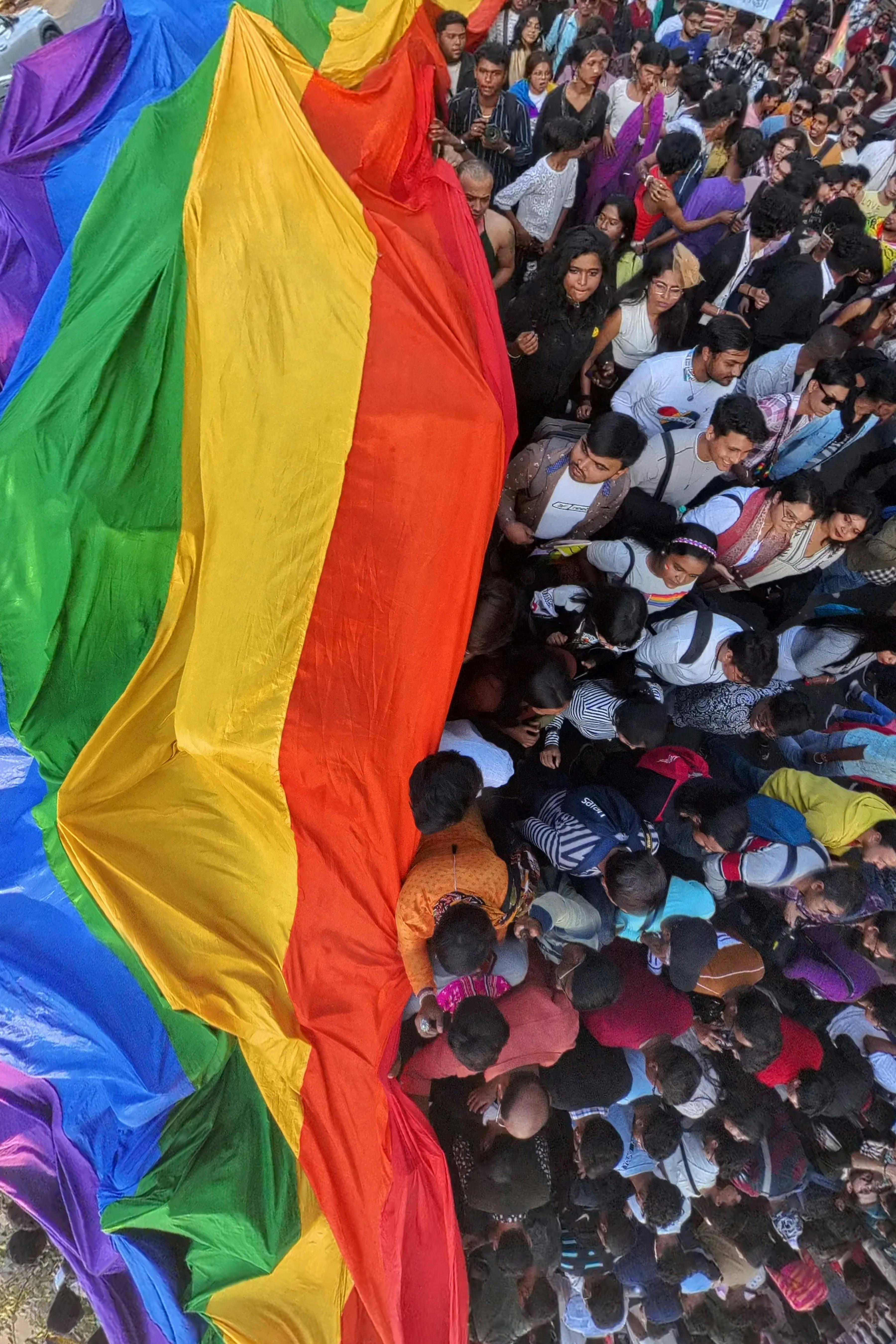 LGBTQ Pride Parade Crowd with Rainbow Flag · Free Stock Photo