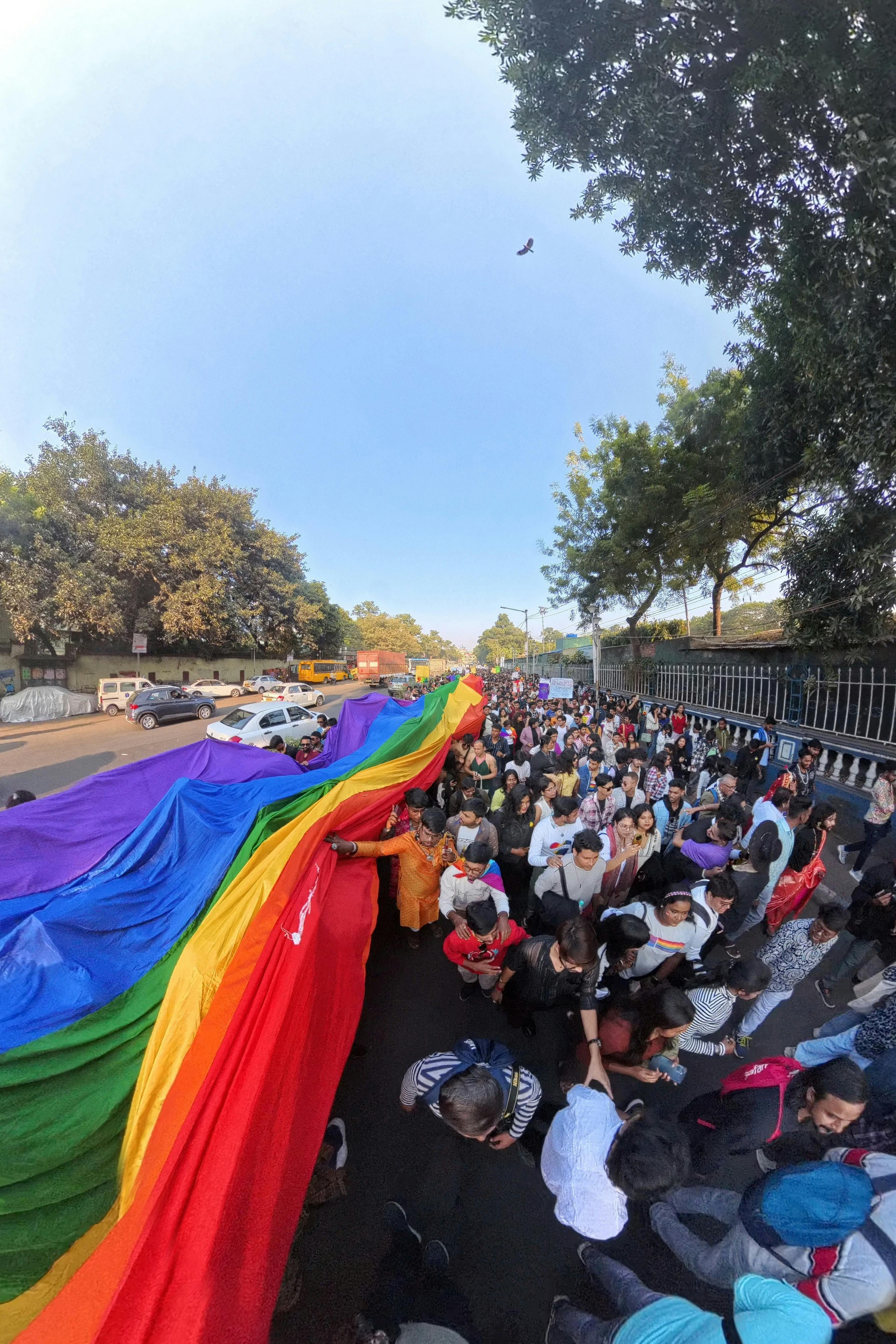 LGBTQ Pride Parade Crowd with Rainbow Flag · Free Stock Photo