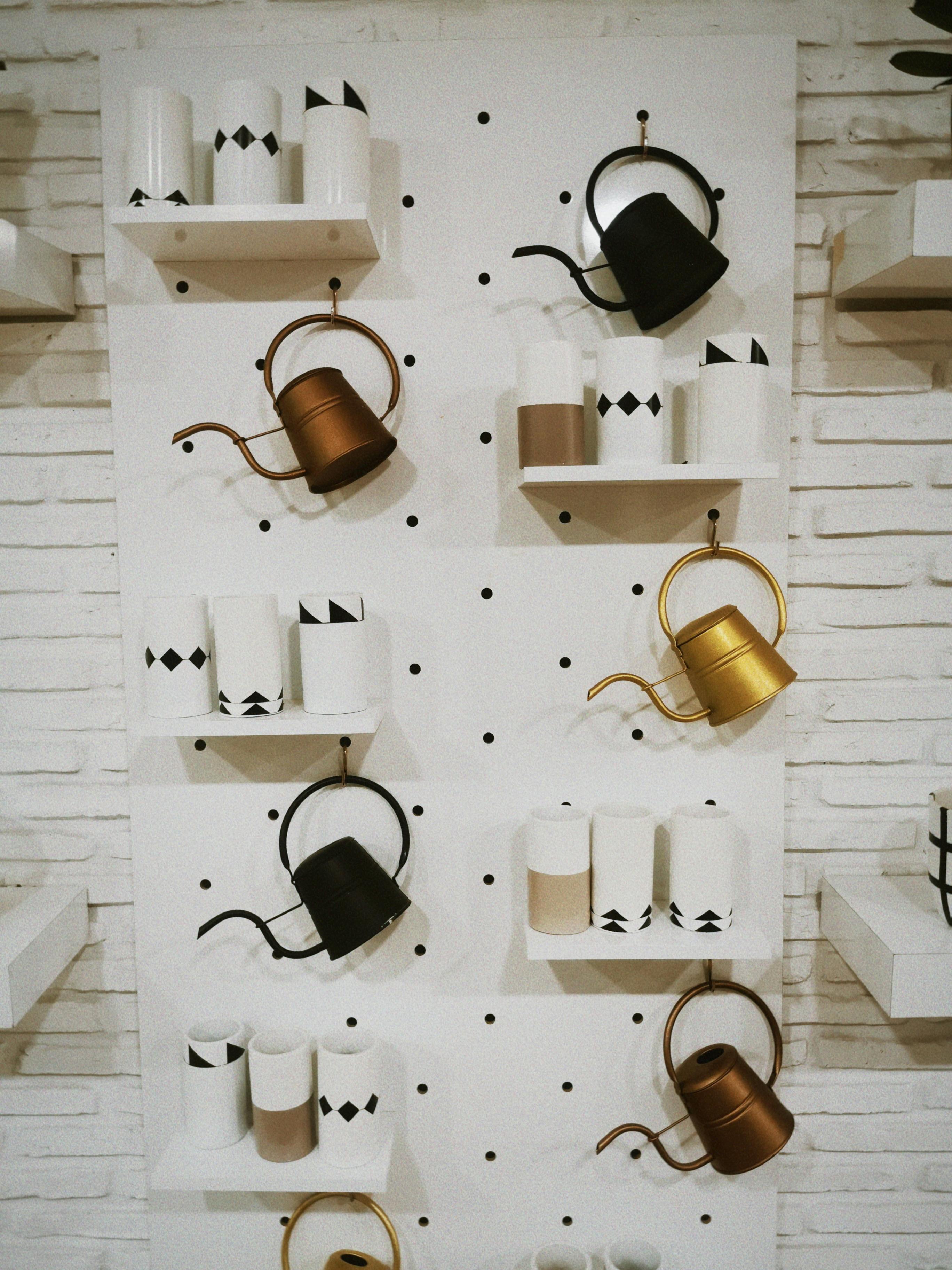 Artistic Hanging Watering Cans Display Wall · Free Stock Photo