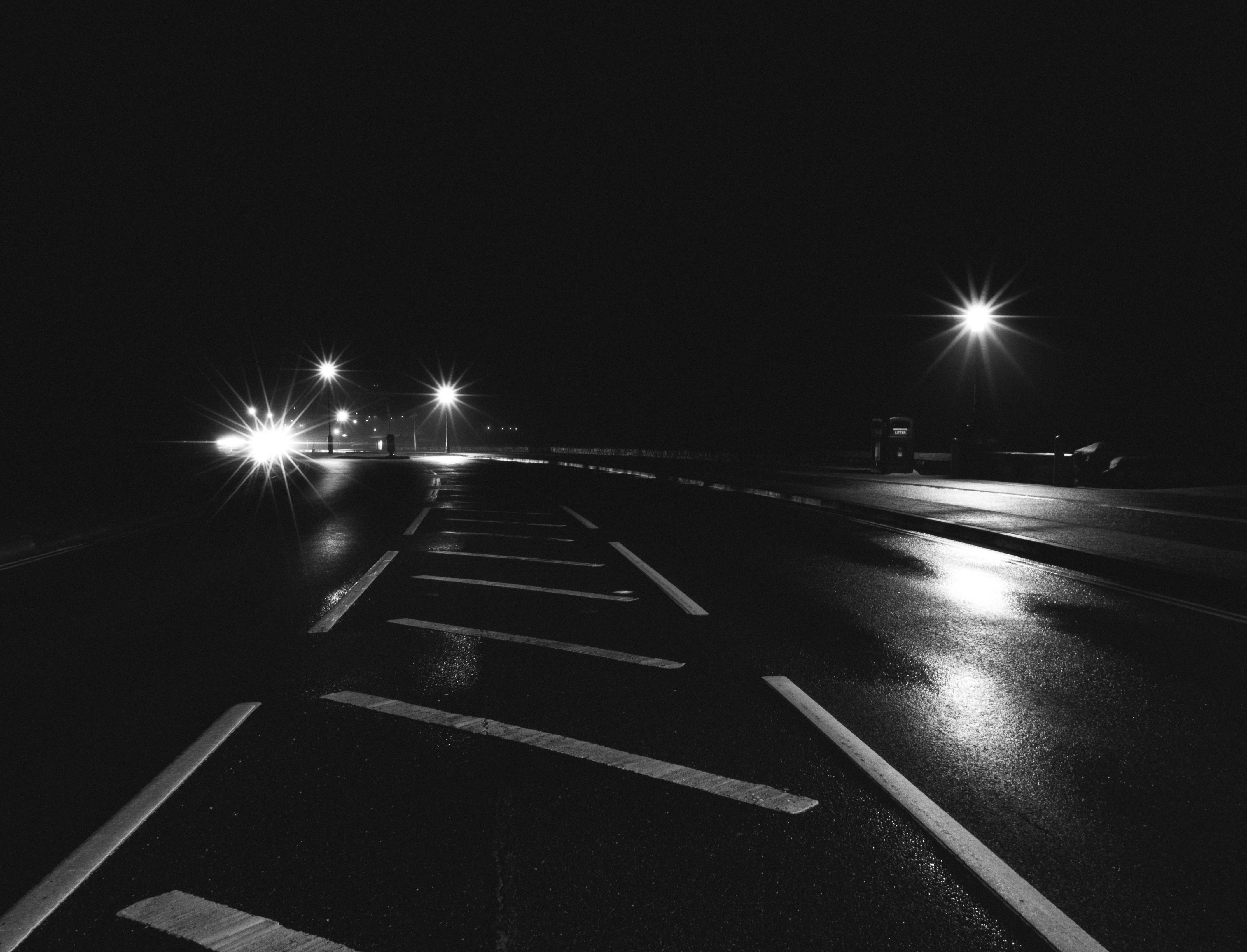 Dramatic Nighttime Road Scene with Bright Streetlights · Free Stock Photo