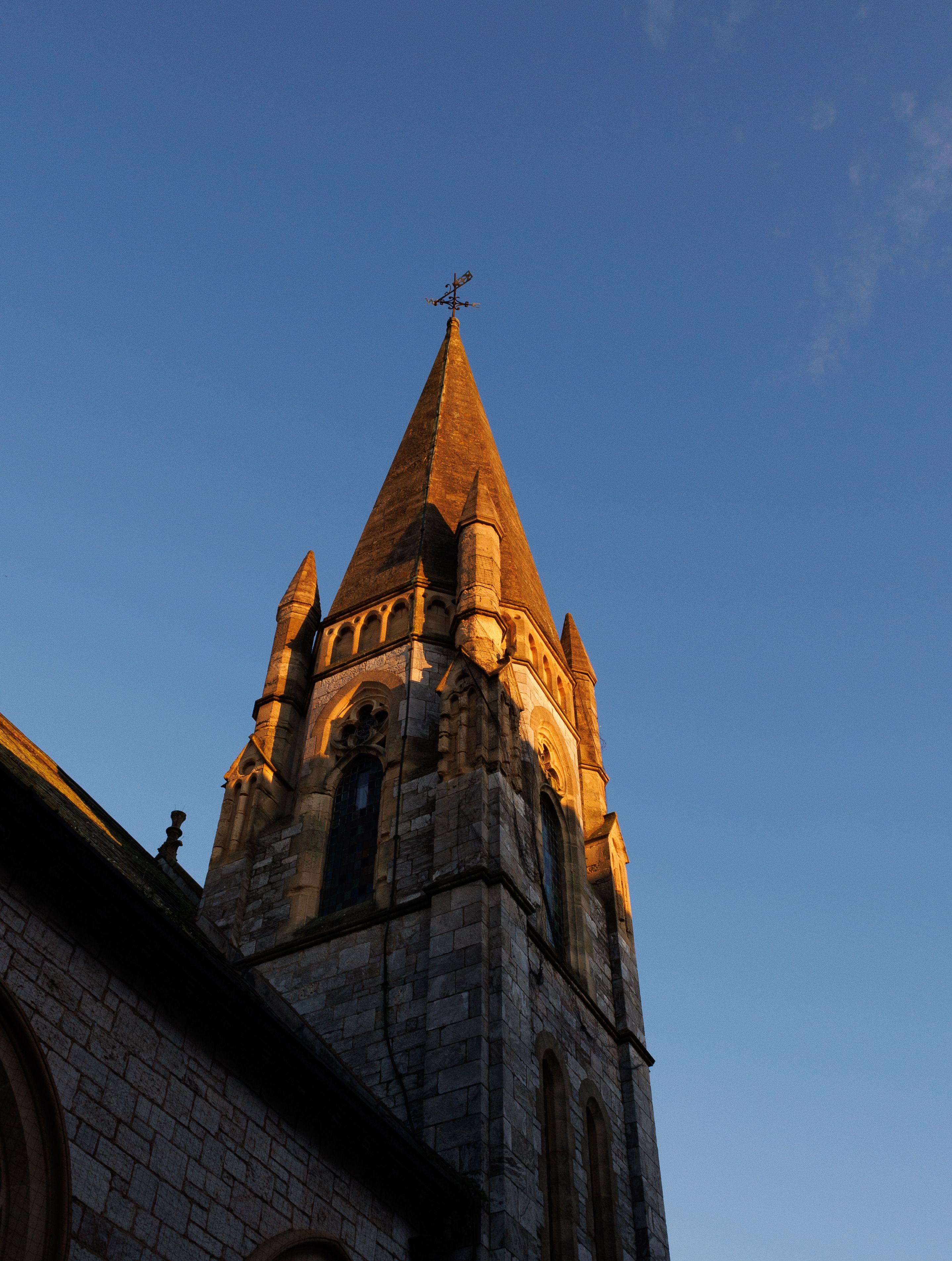 Iconic Gothic Church Tower at Sunset · Free Stock Photo