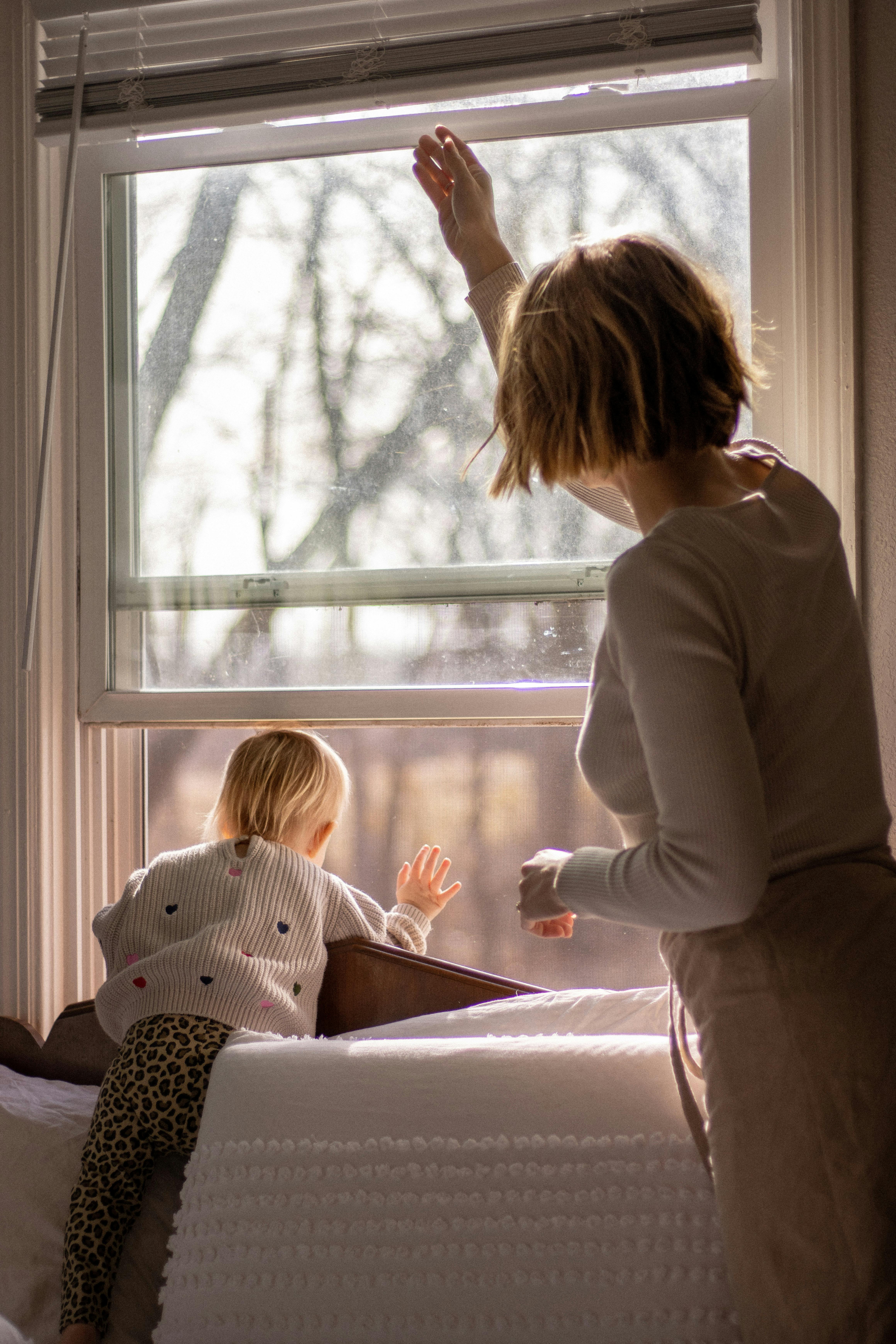 Mother and Child Enjoying Natural Light at Home · Free Stock Photo