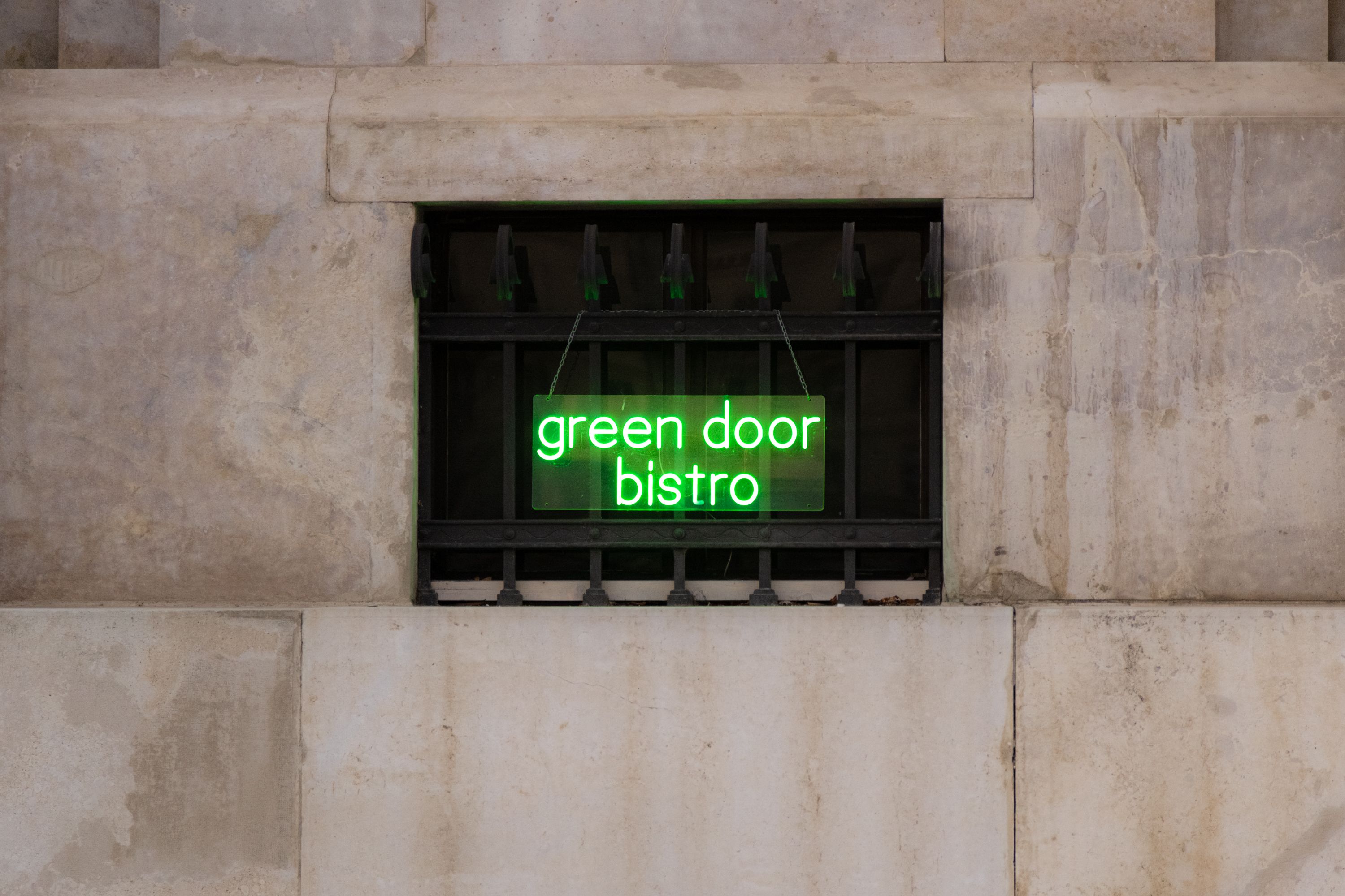 Neon Sign for Green Door Bistro on Stone Wall · Free Stock Photo