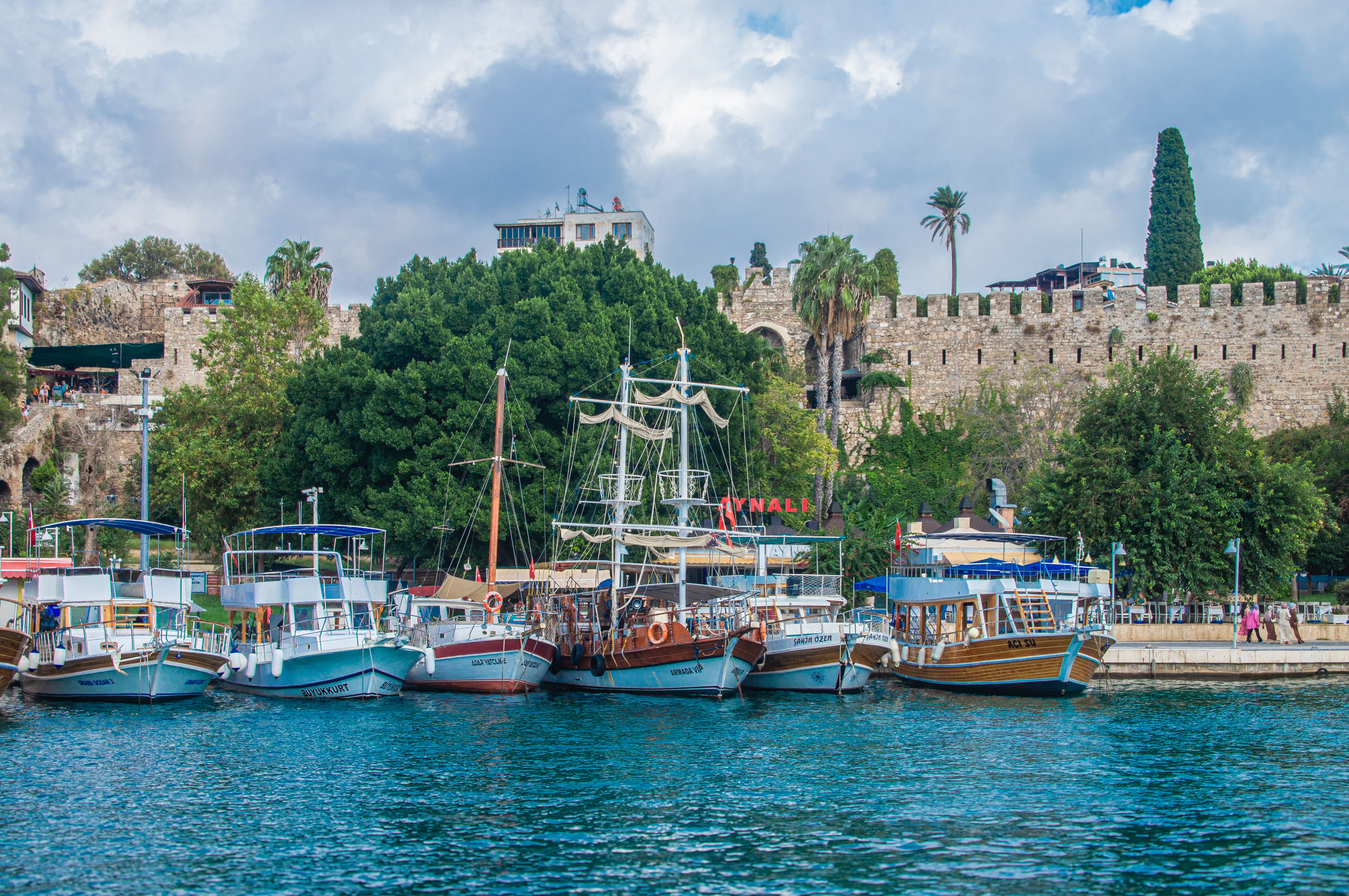 Boats Docked by Ancient Fortress in Harbor · Free Stock Photo