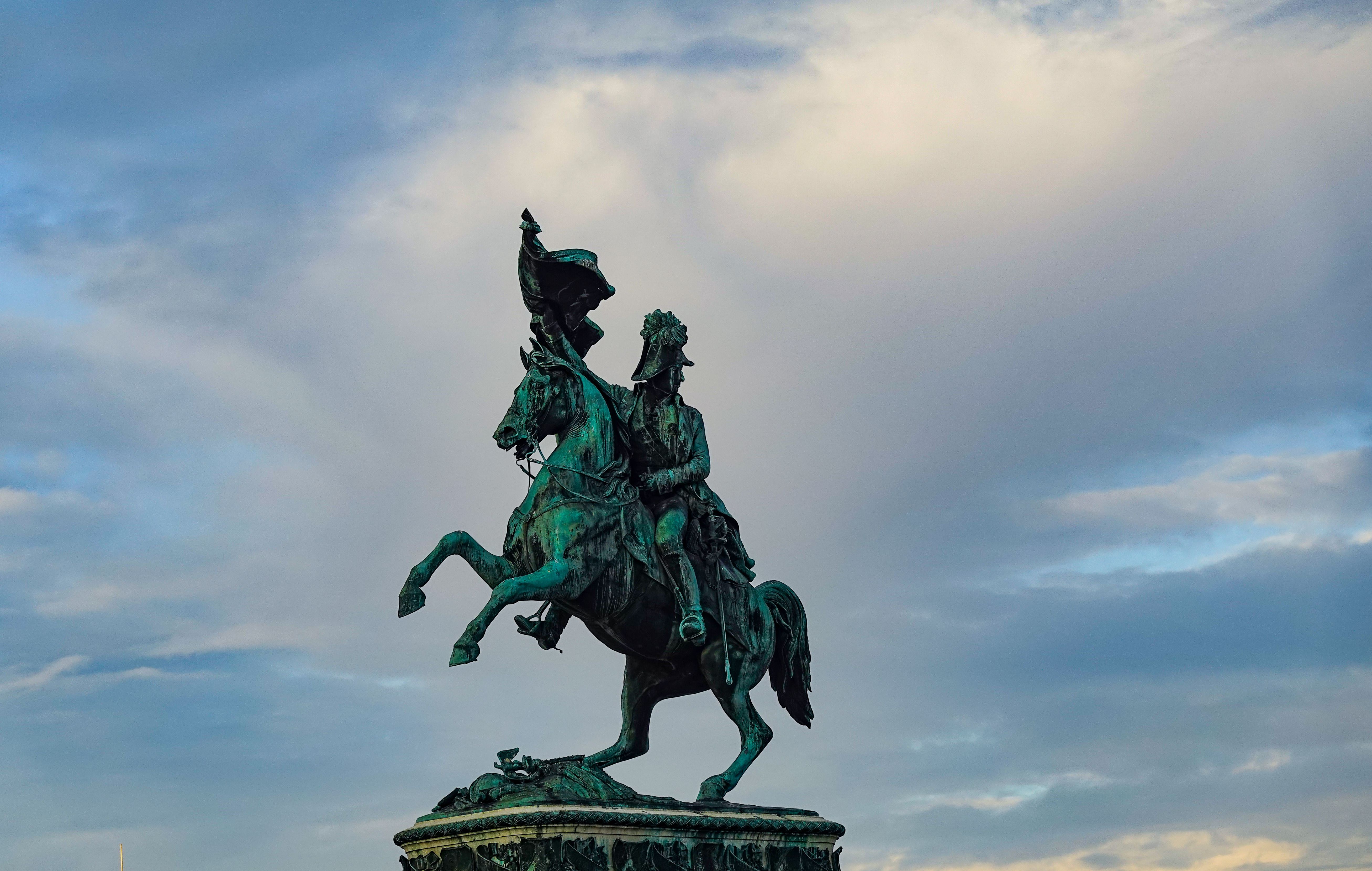 Man Standing in Front of Statue Photo · Free Stock Photo