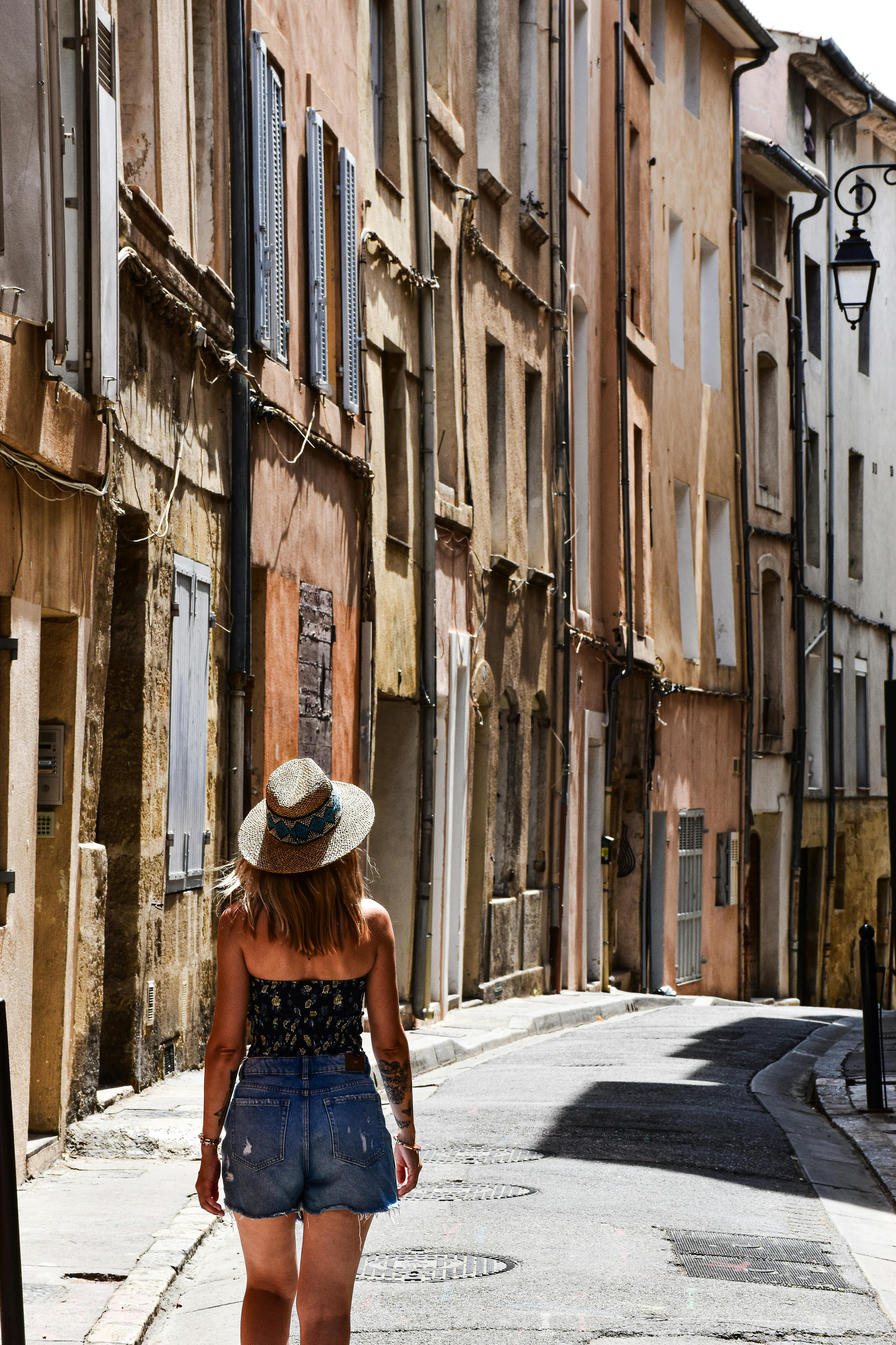 Back View of Tourist Exploring Aix-en-Provence Streets · Free Stock Photo