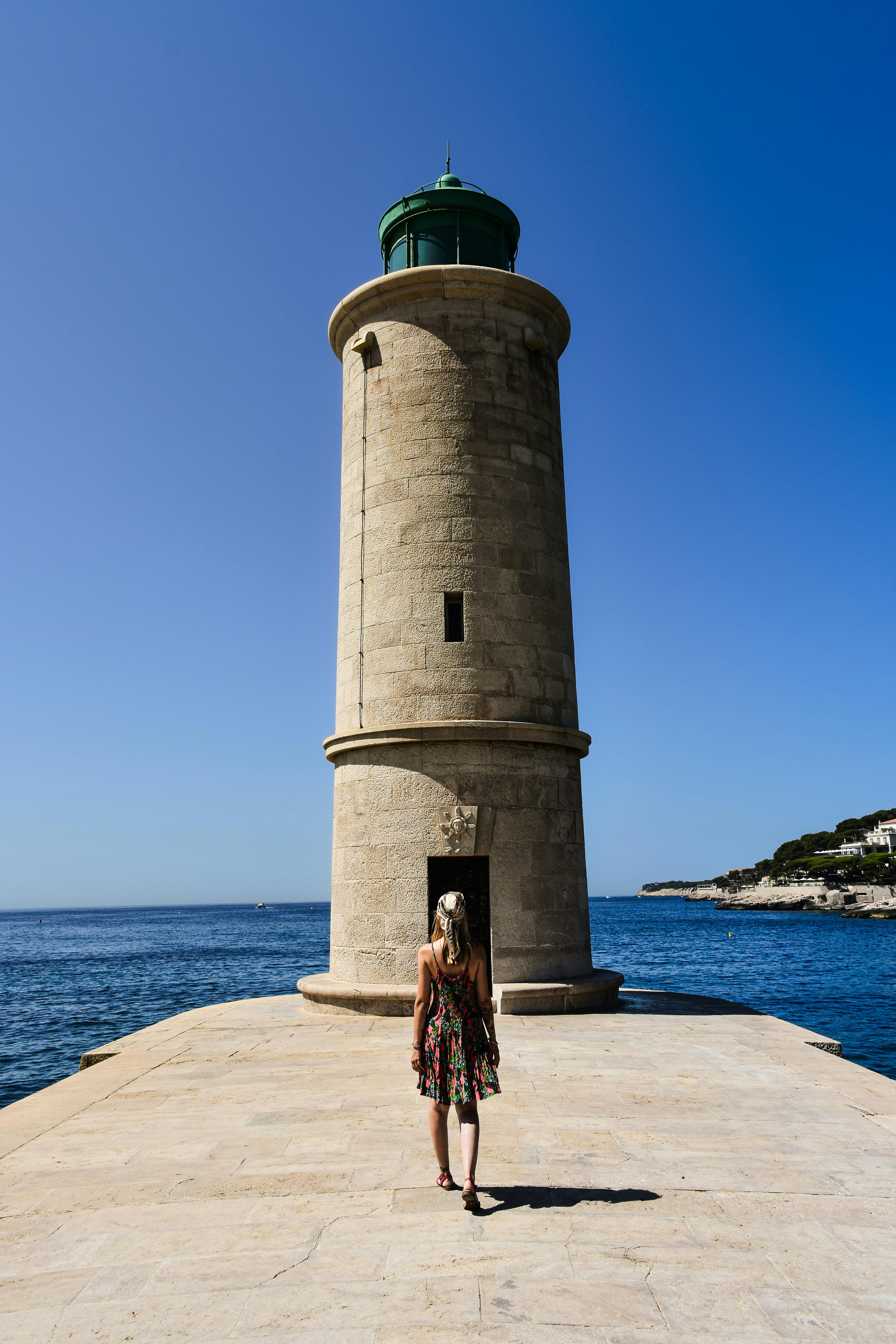Woman Walking Towards Lighthouse in Cassis, France · Free Stock Photo