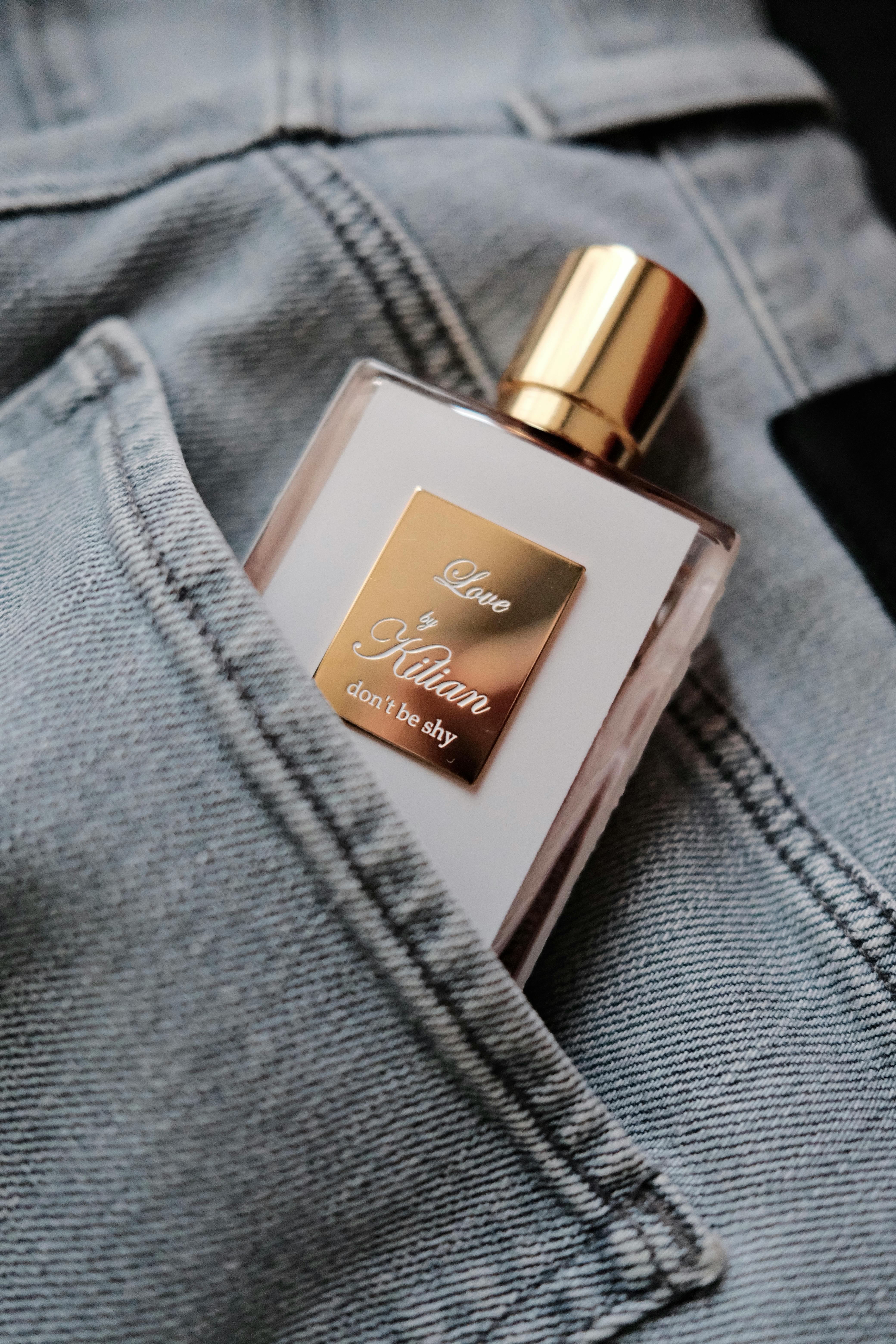 Luxury Perfume in Denim Pocket Close-Up · Free Stock Photo