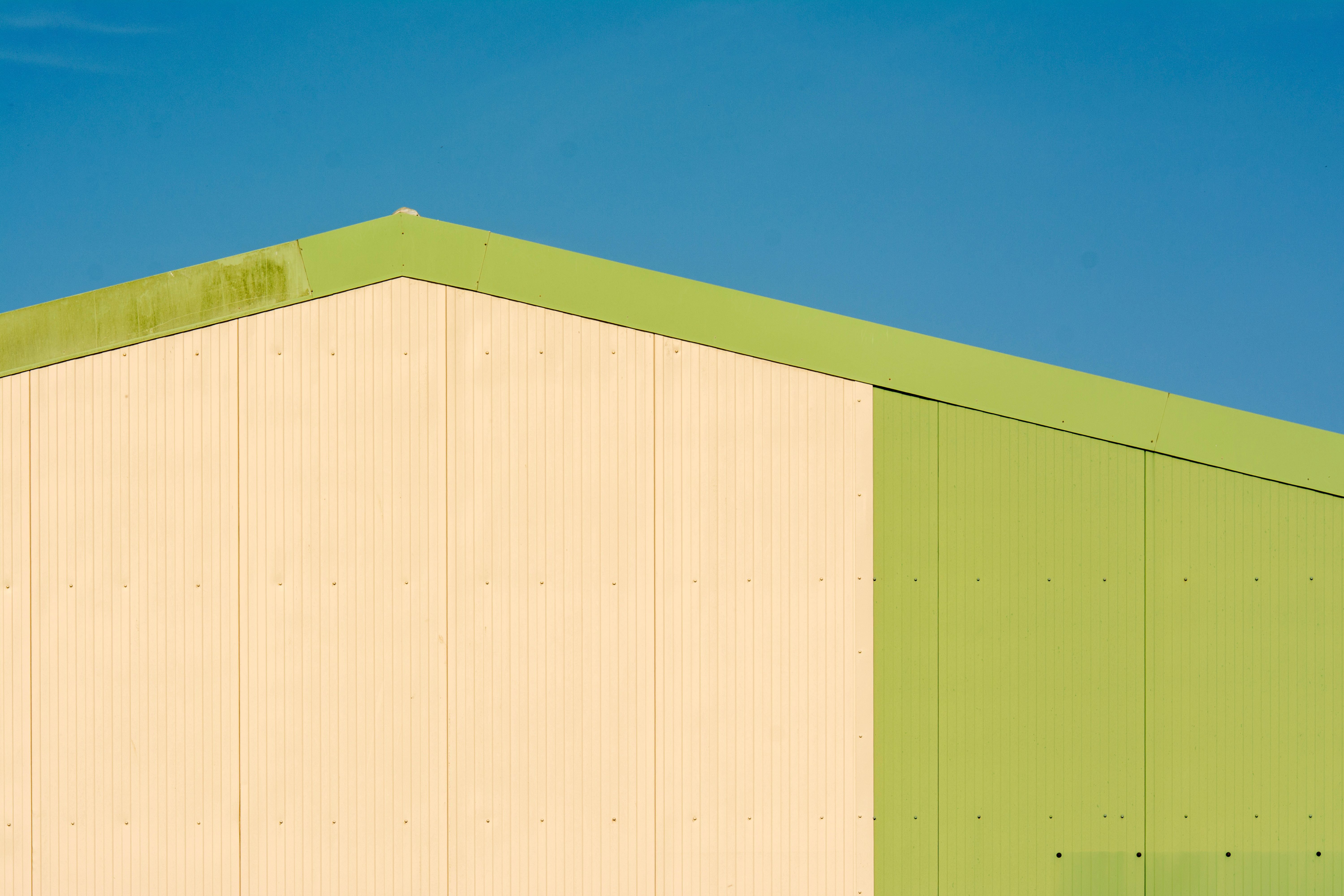 Minimalist Warehouse Facade Against Clear Sky · Free Stock Photo