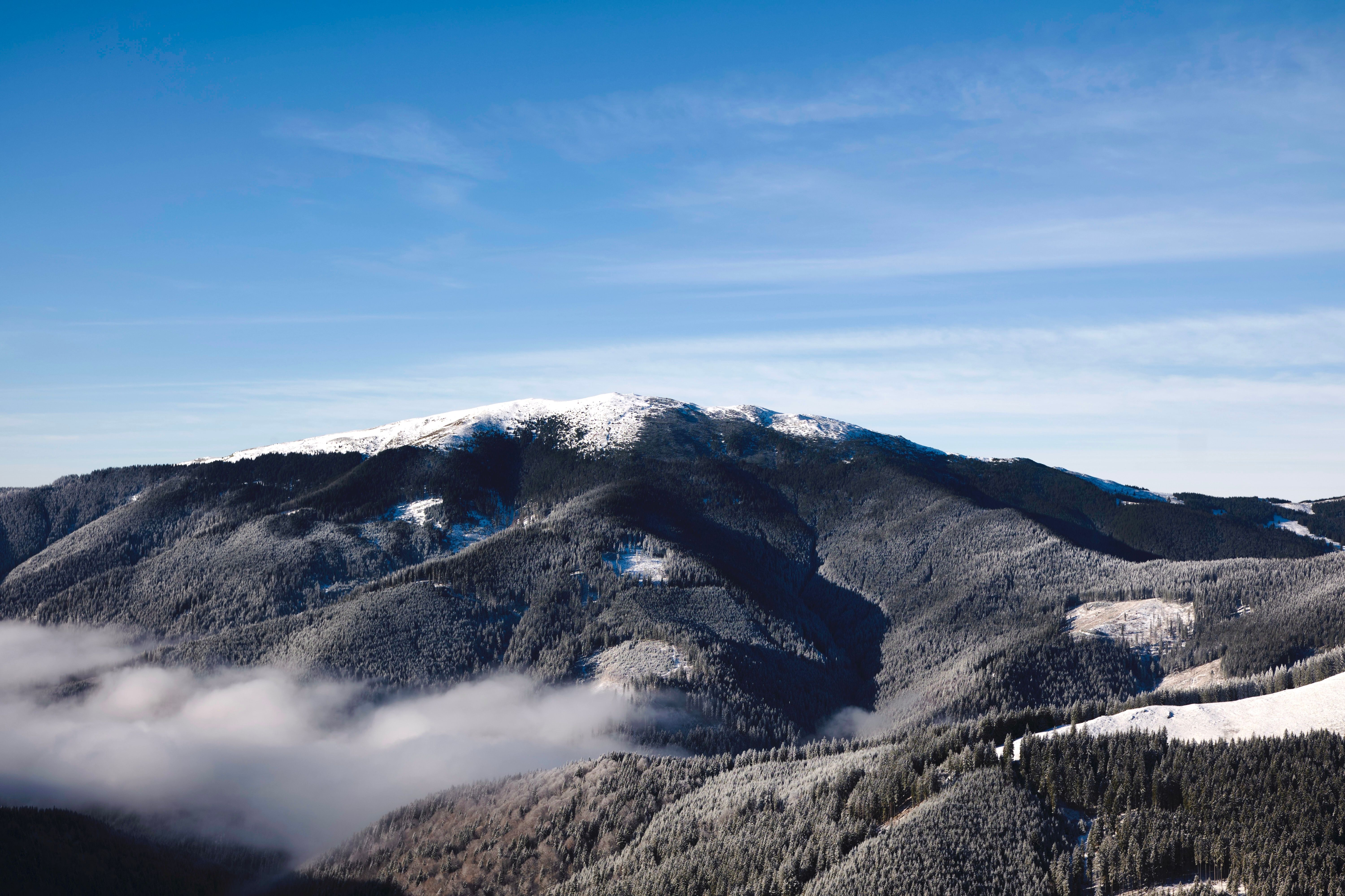 Snow-covered Mountain Range Under Blue Skies · Free Stock Photo