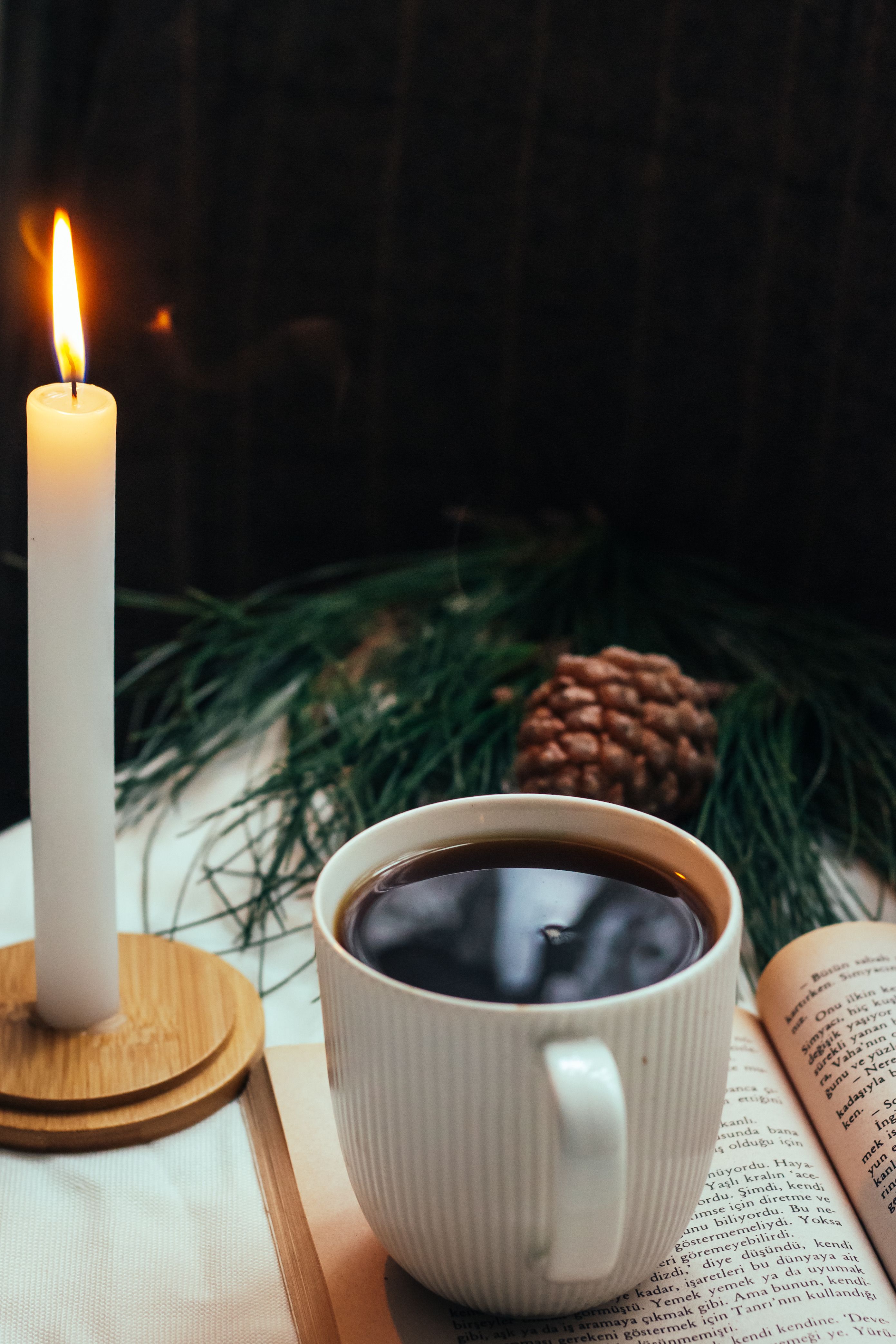 Cozy Winter Scene with Coffee and Candlelight · Free Stock Photo