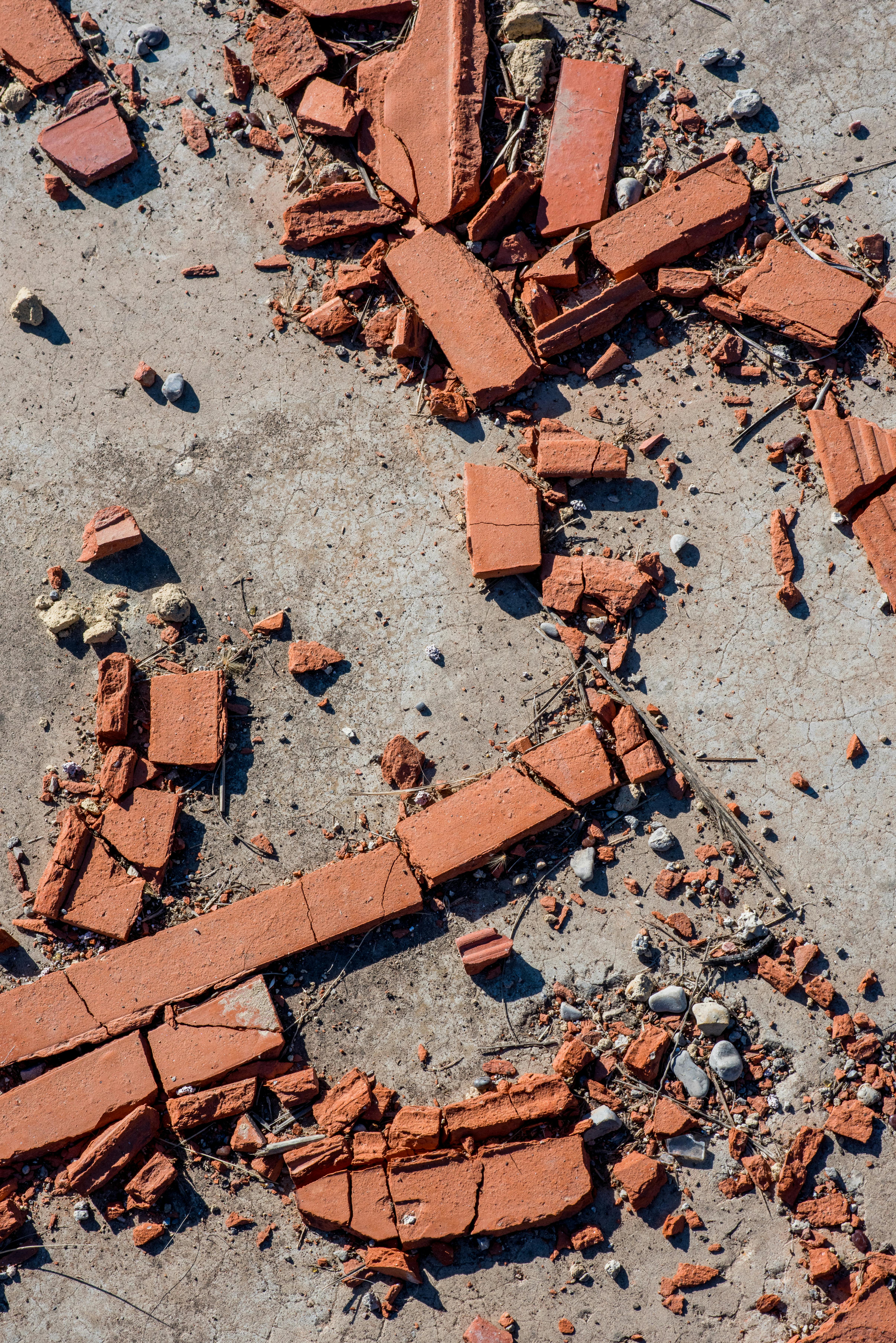 Broken Red Bricks on Concrete Surface · Free Stock Photo