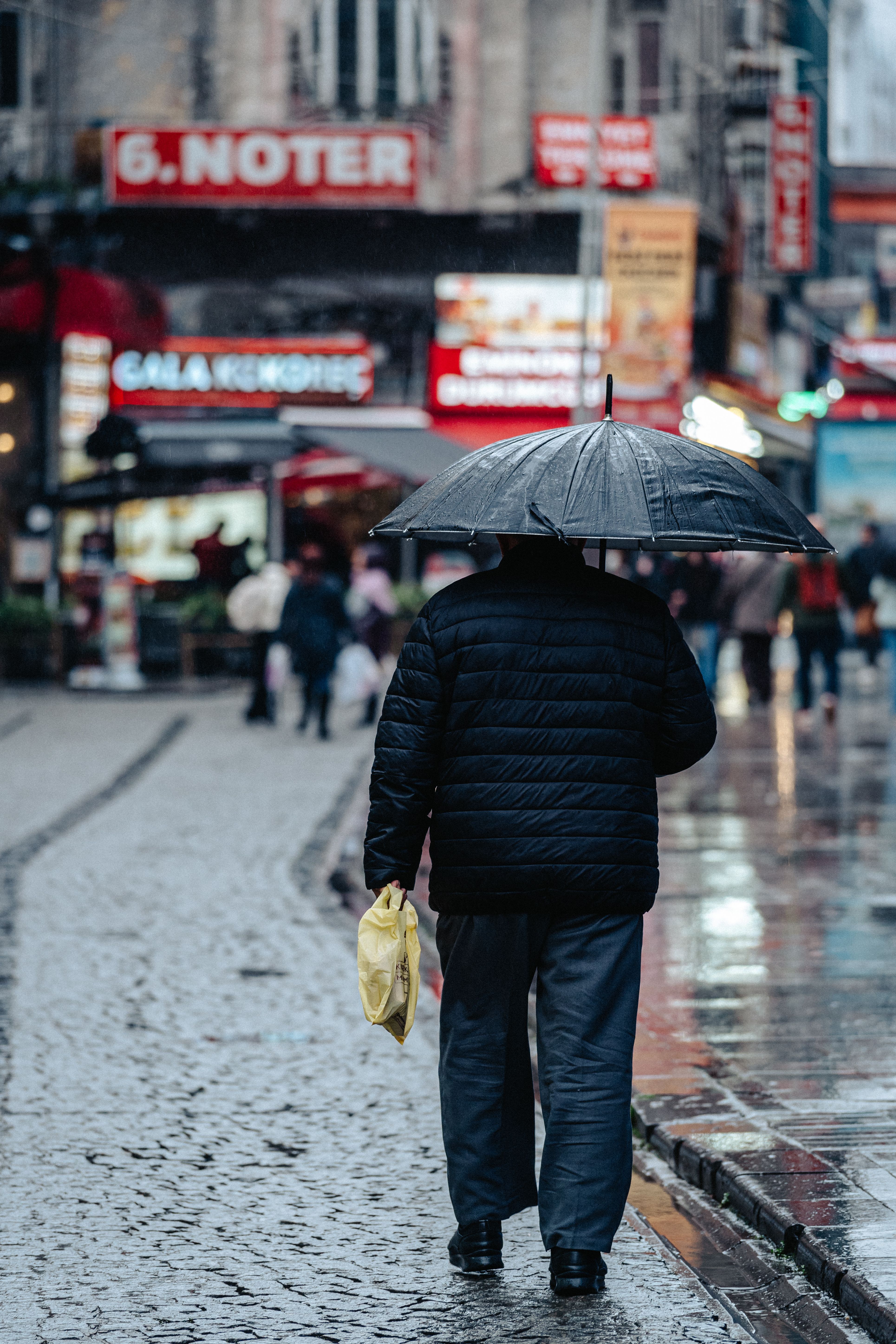 Rainy Day Street Scene with Umbrella in Istanbul · Free Stock Photo