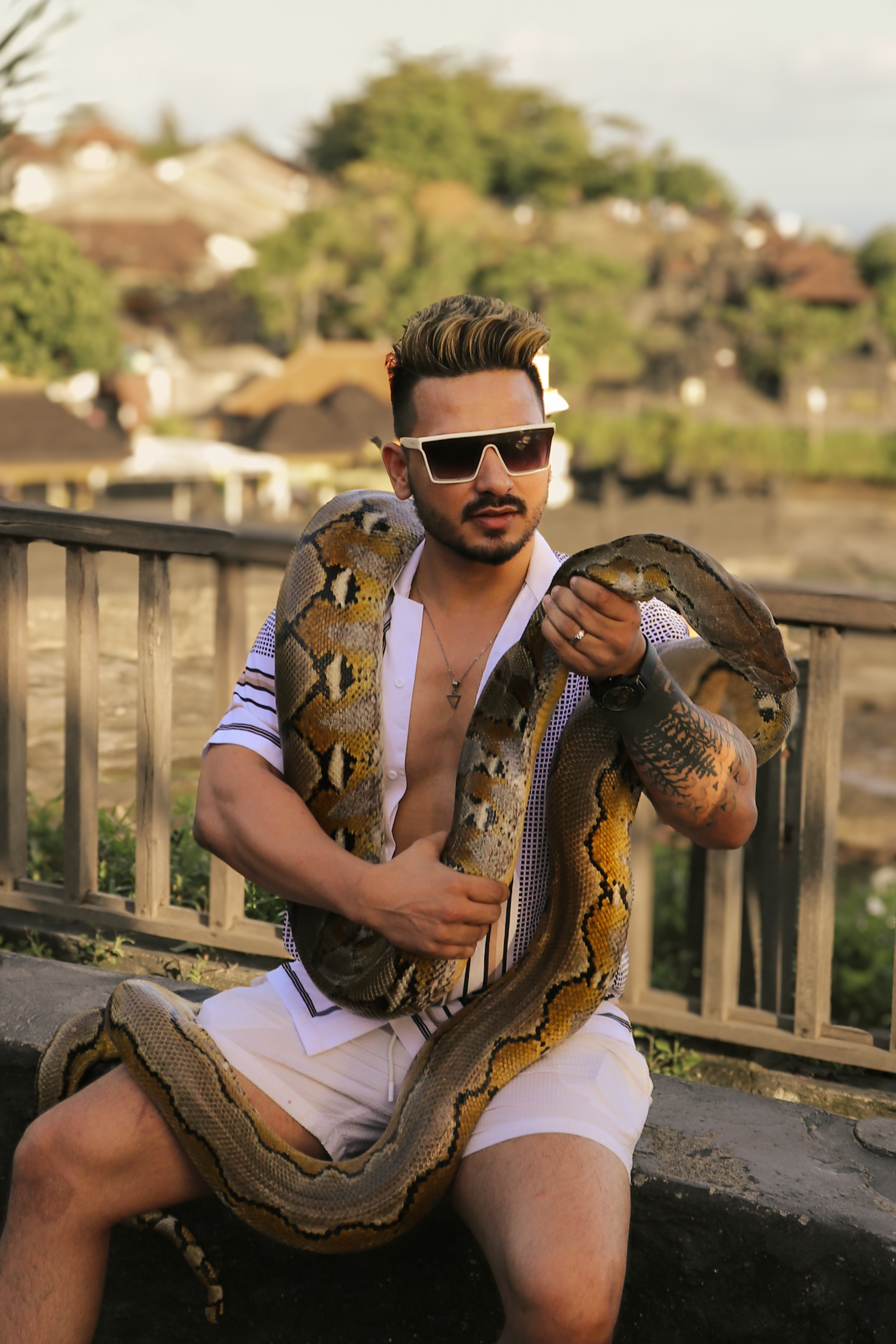 Man Holding Python in Bali Outdoors · Free Stock Photo