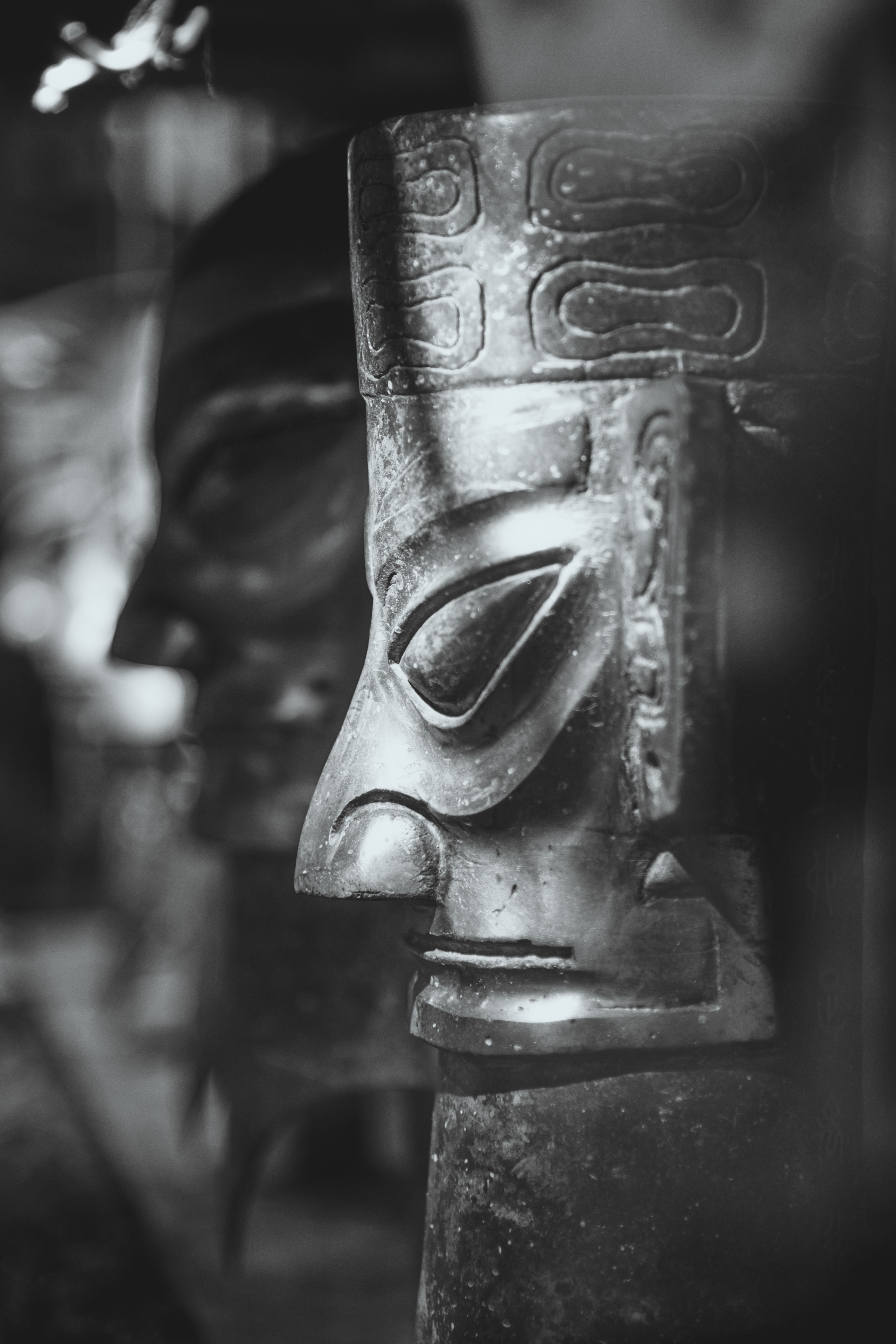 Ancient Metallic Mask Display in Monochrome · Free Stock Photo