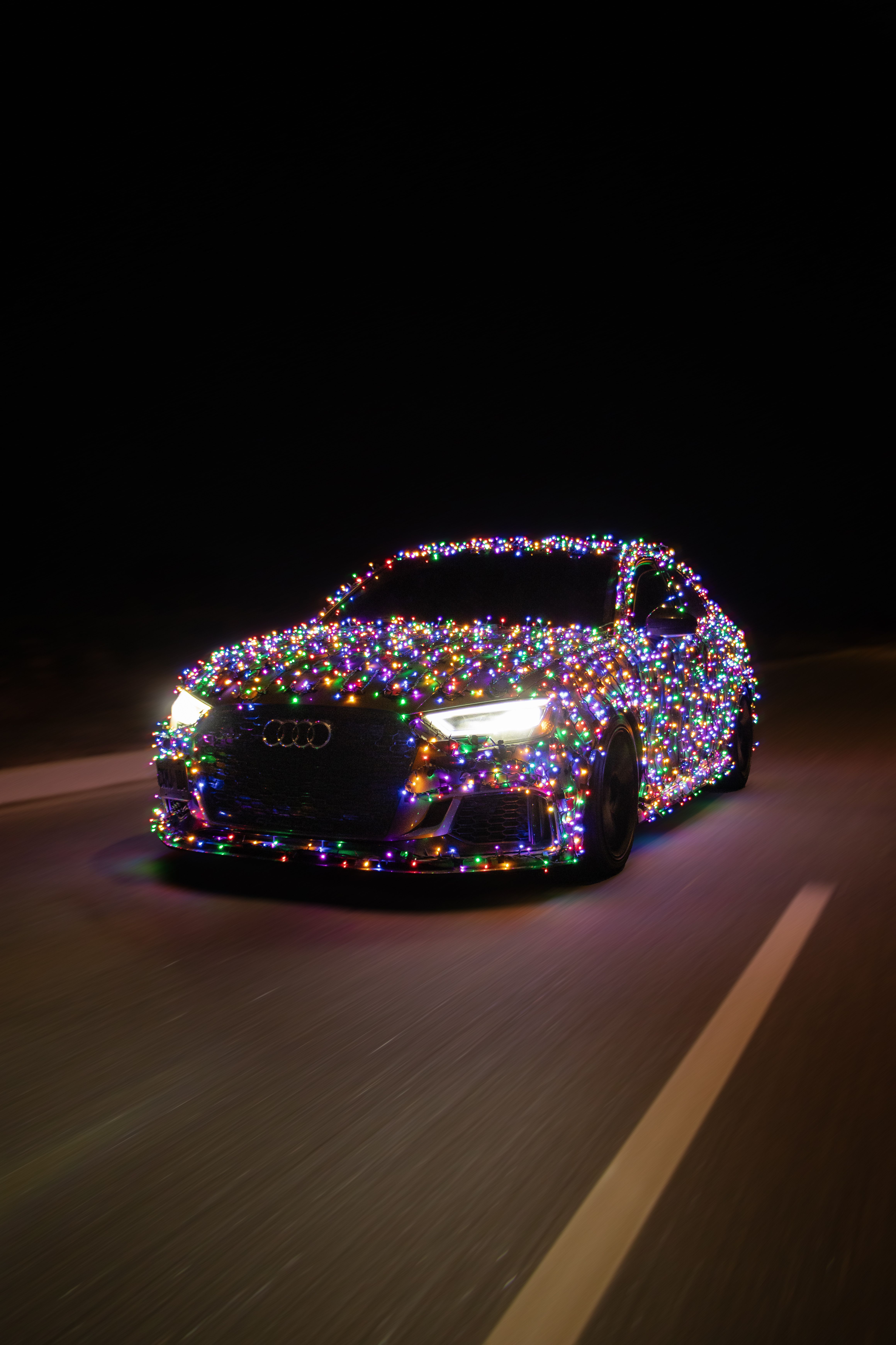 Car Wrapped in Vibrant Christmas Lights at Night · Free Stock Photo
