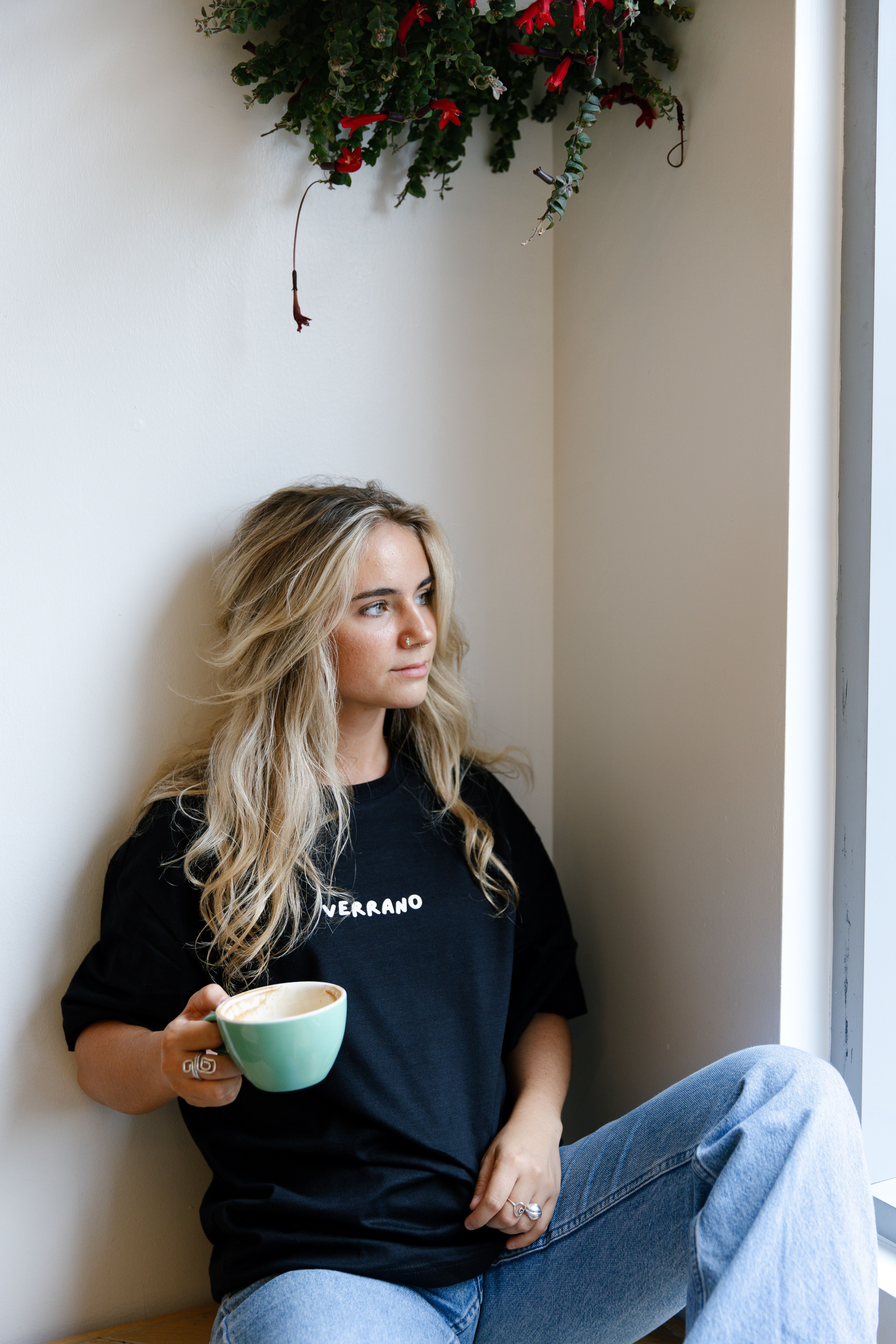Young Woman Enjoying Coffee by a Window · Free Stock Photo