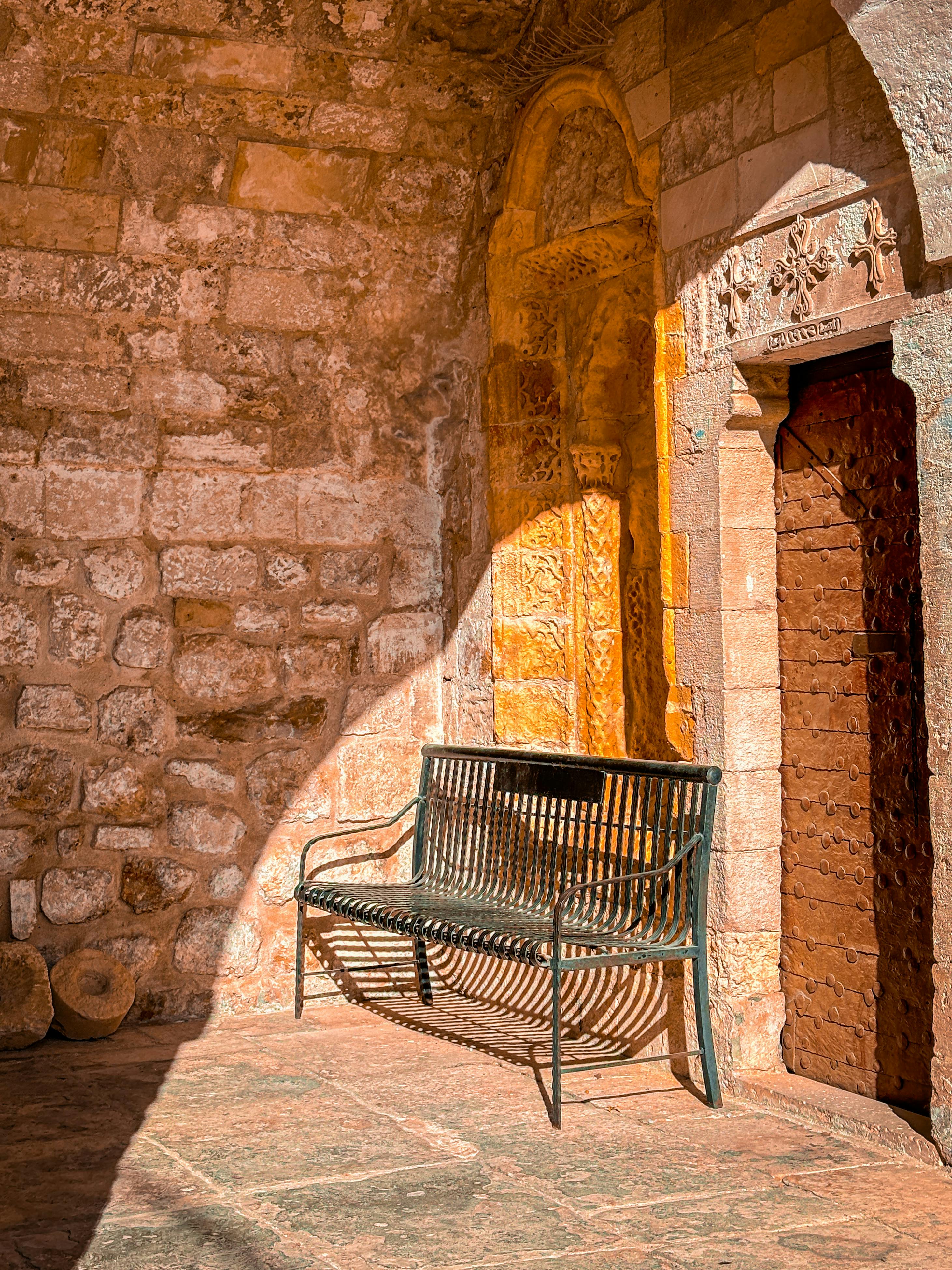 Historic Stone Courtyard Bench with Sunlight · Free Stock Photo