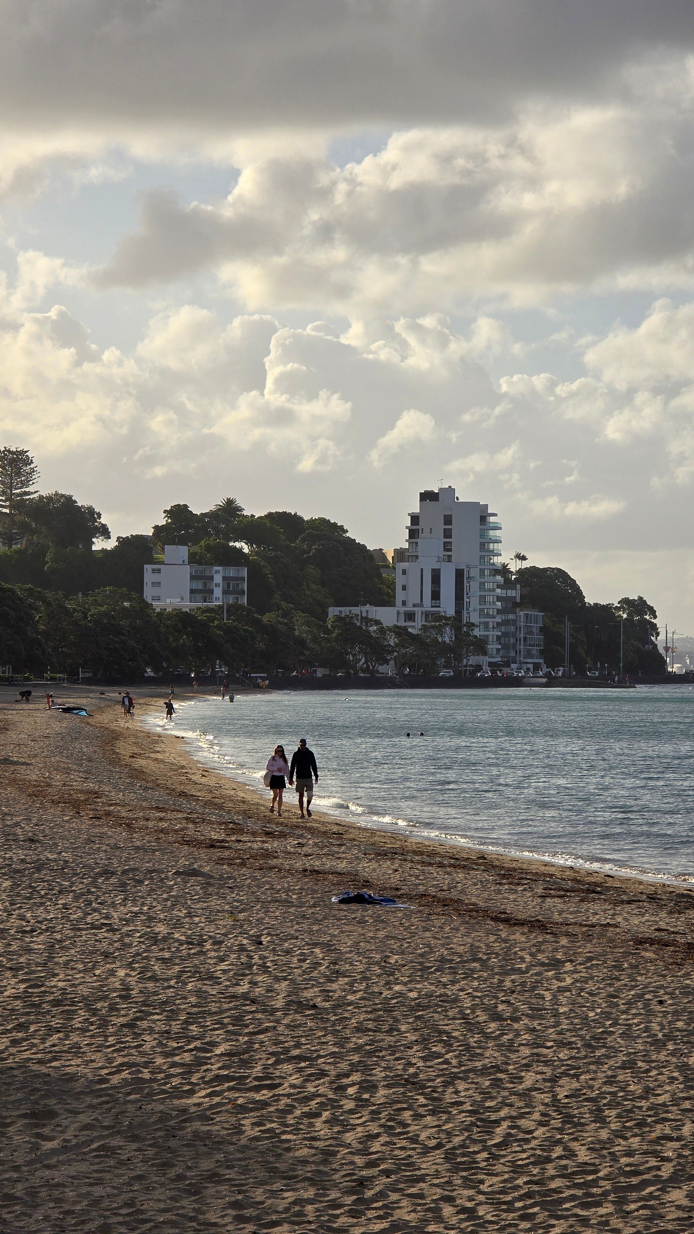Romantic Walk on Sandy Beach by Modern City · Free Stock Photo