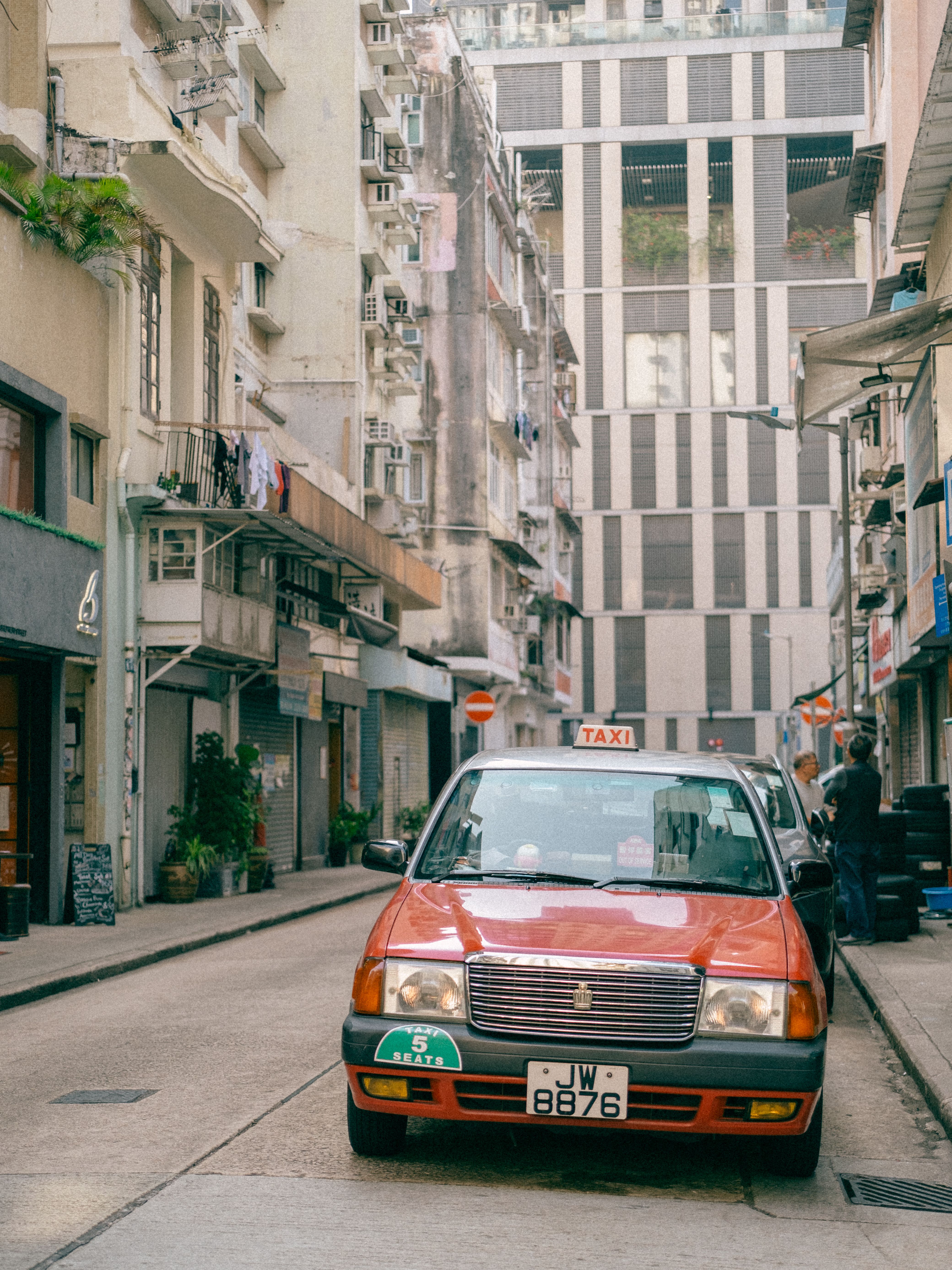 Red Taxi on Urban Street in Vibrant City · Free Stock Photo