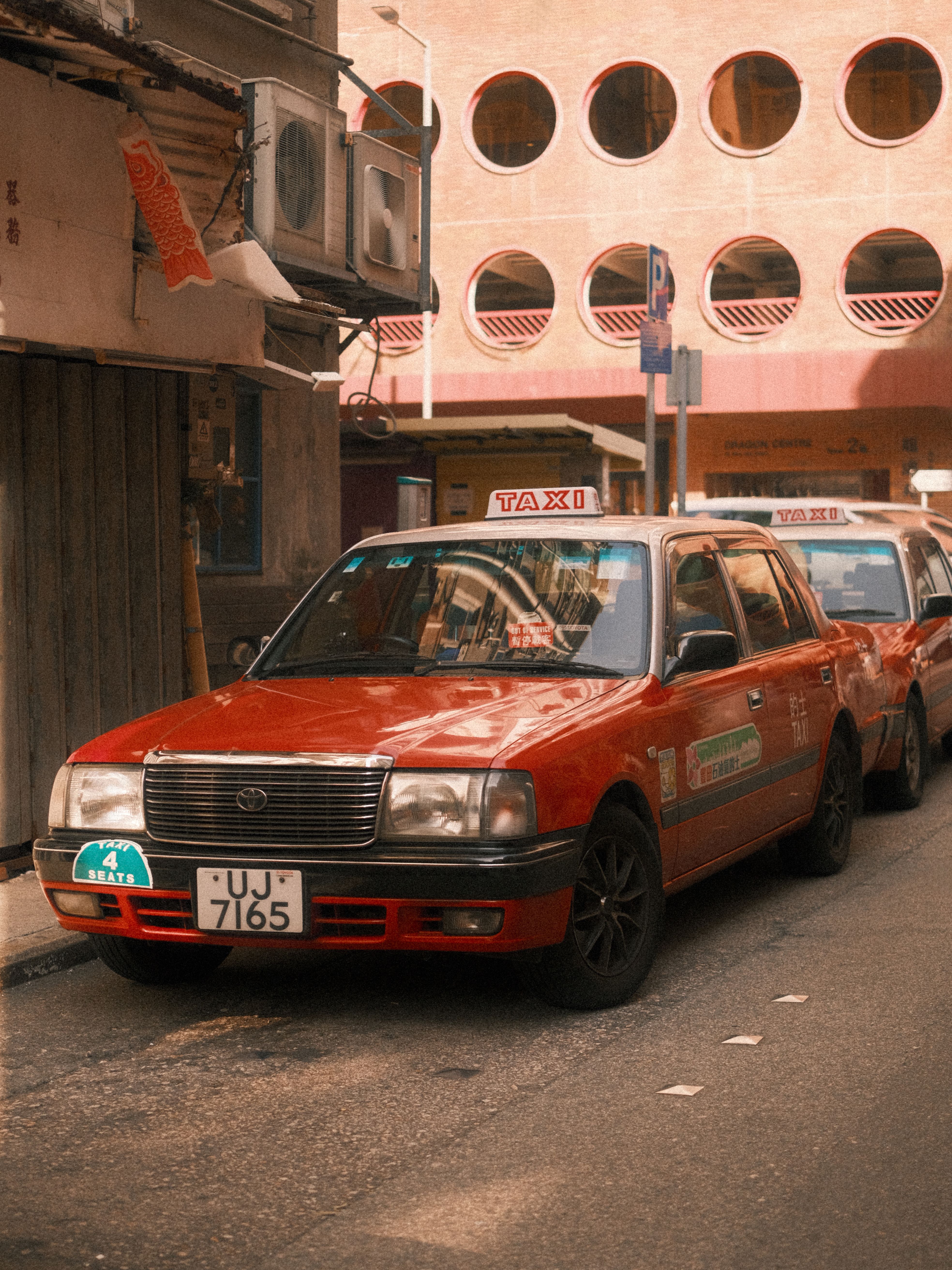 Red Taxi in Urban Street Setting · Free Stock Photo