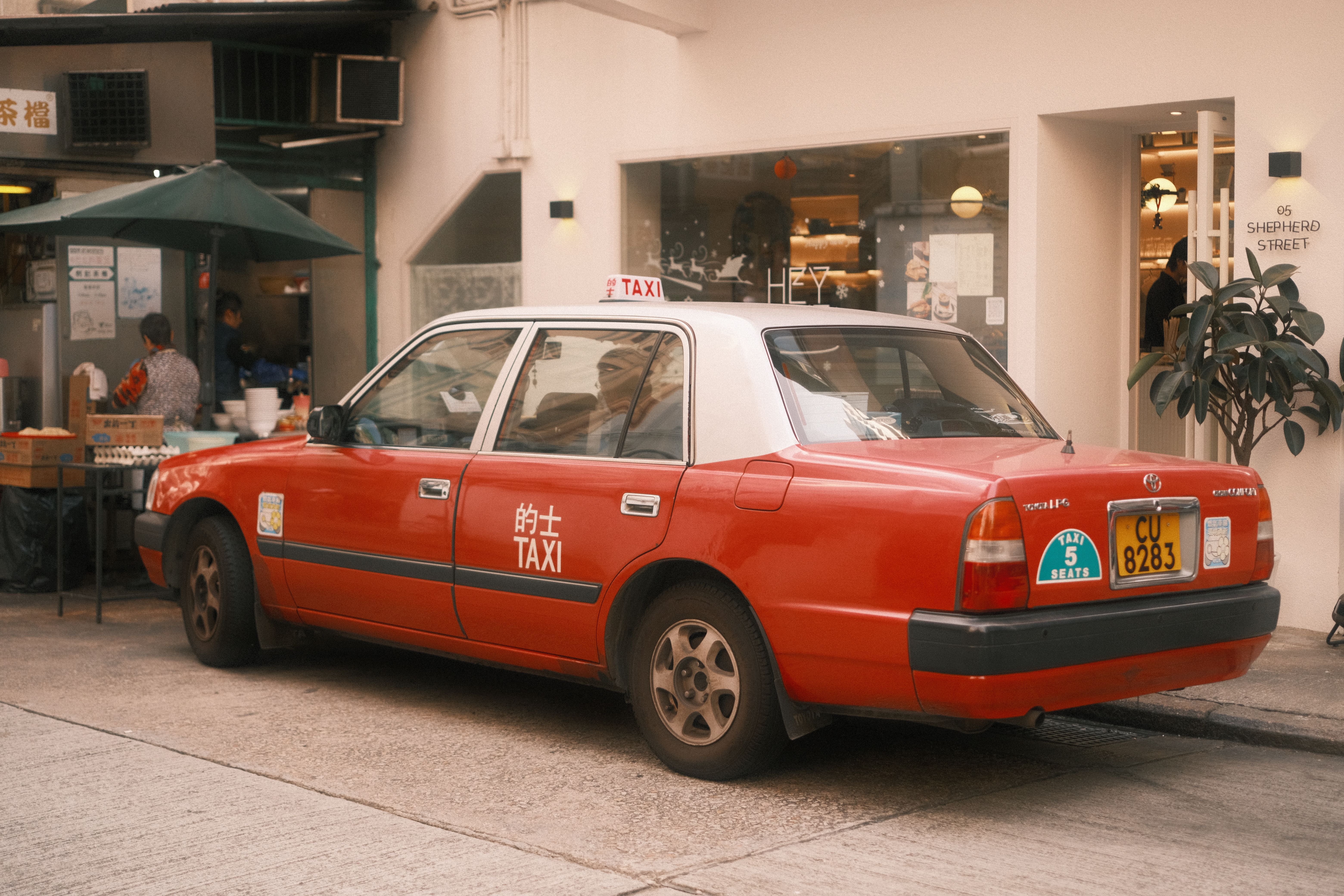 Classic Red Taxi Parked on Hong Kong Street · Free Stock Photo