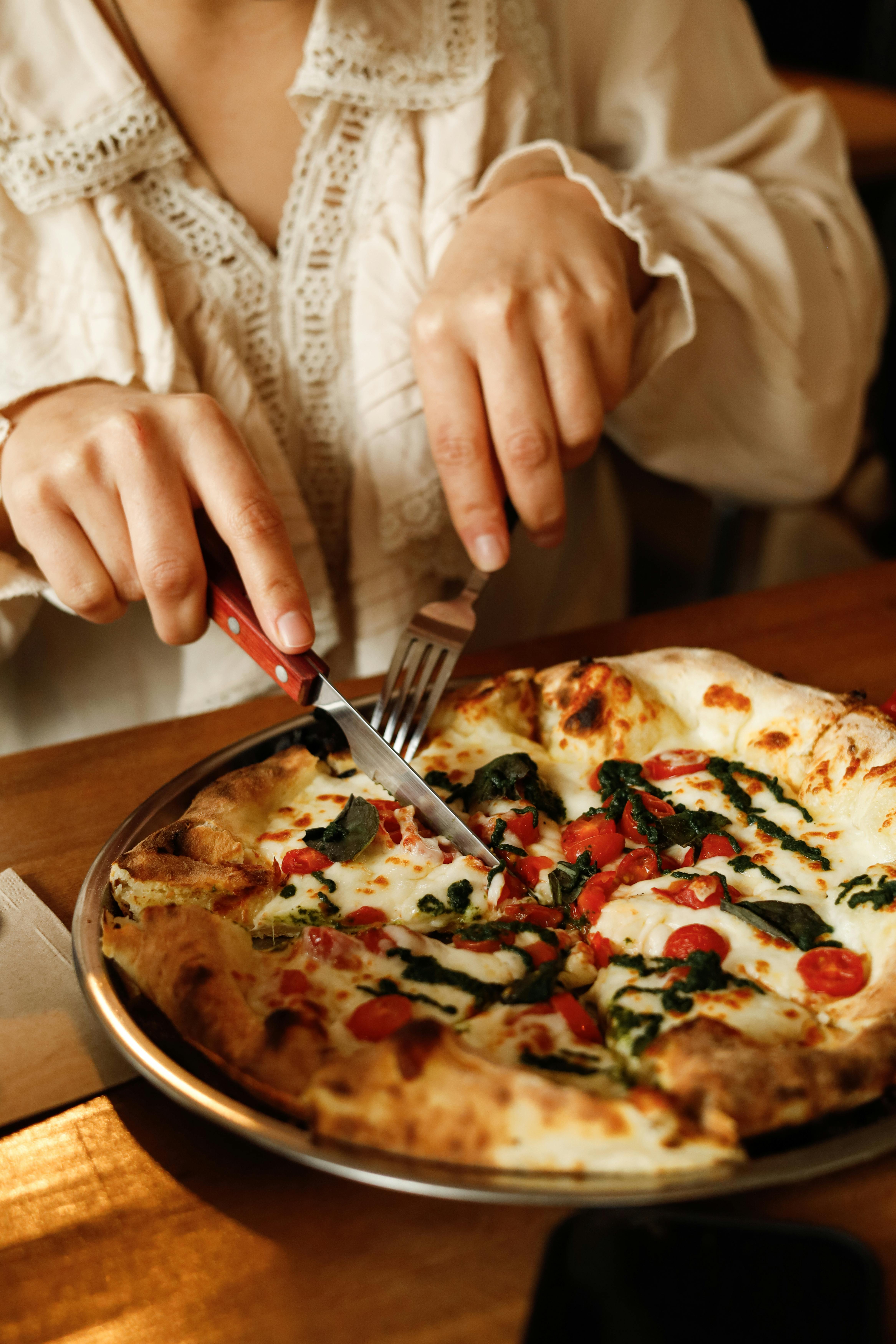Person Slicing Pizza · Free Stock Photo